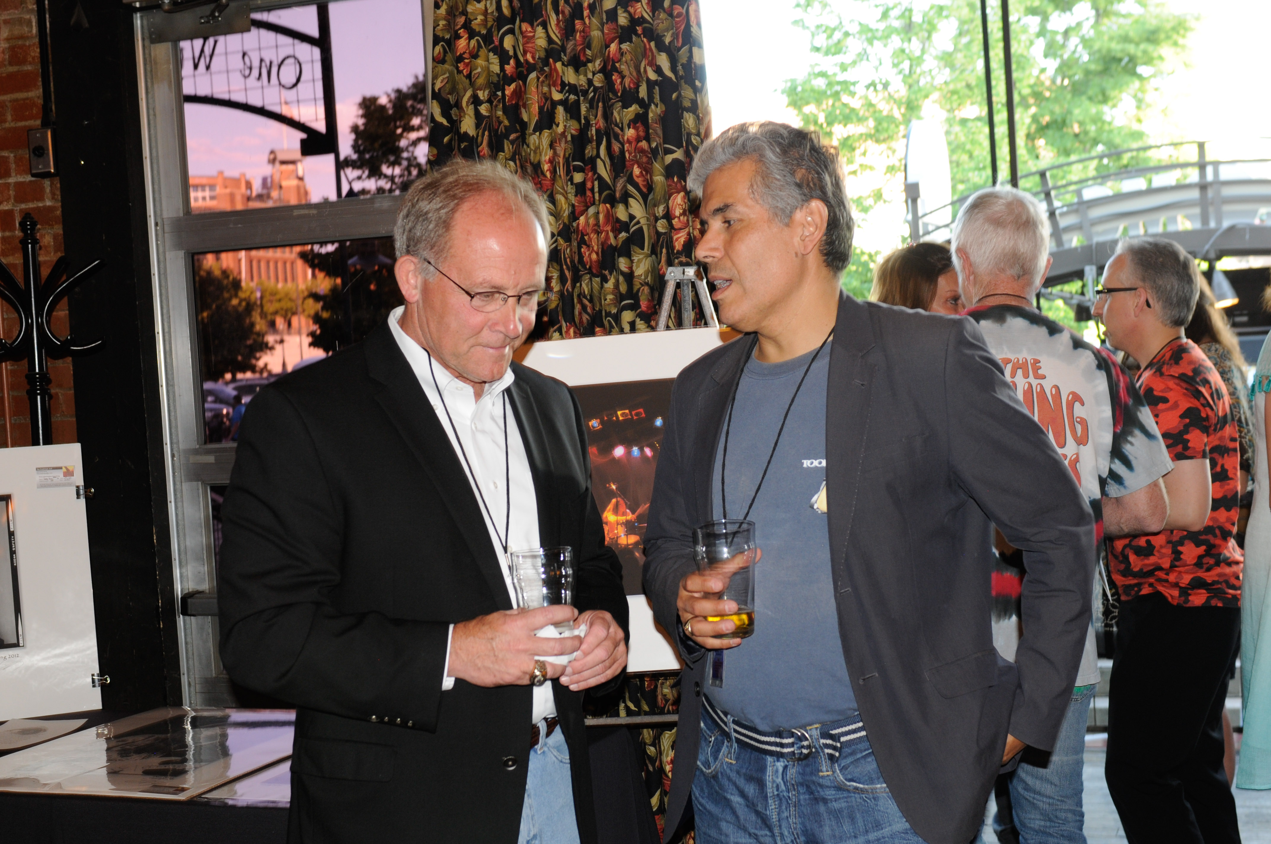 Former Denver Bronco Bucky Dilts, left, talks with Don Mares