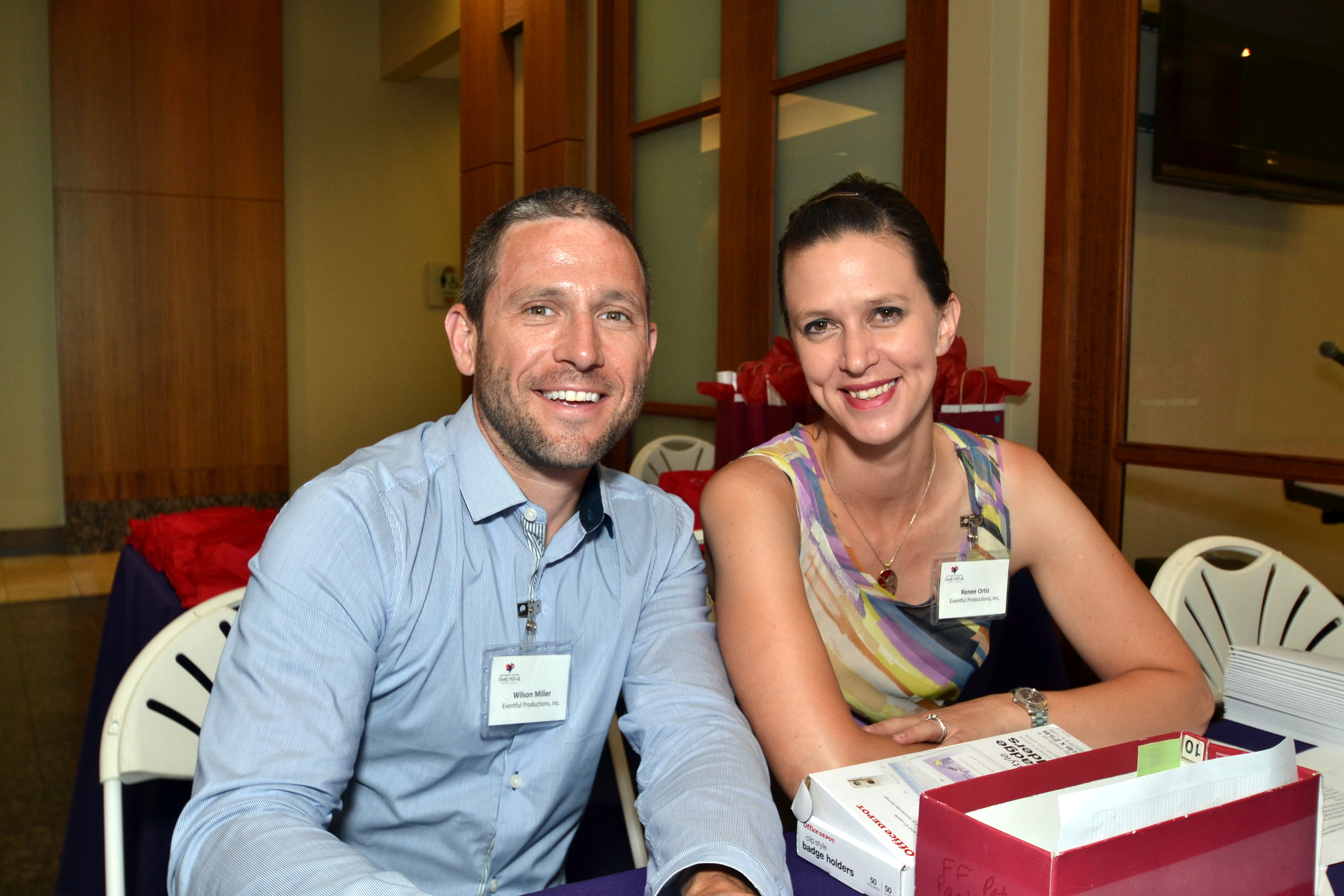 Wilson Miller and Renee Ortiz check guests in as they arrive