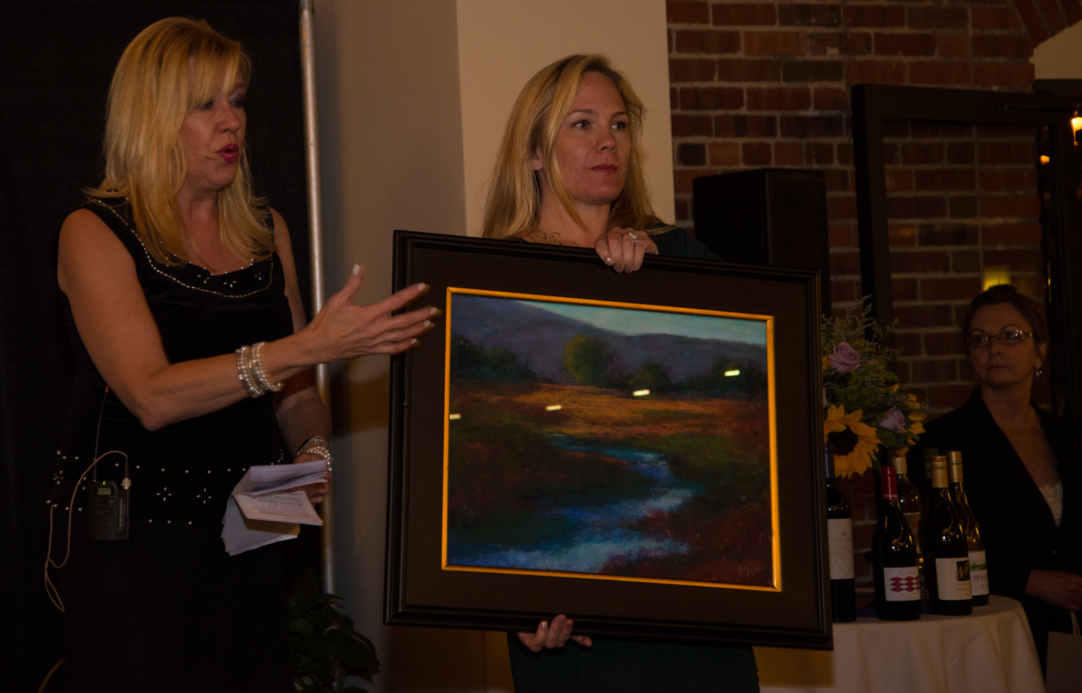 Auctioneer Shelly St. John, left, and Libby Pollack with one of the ...