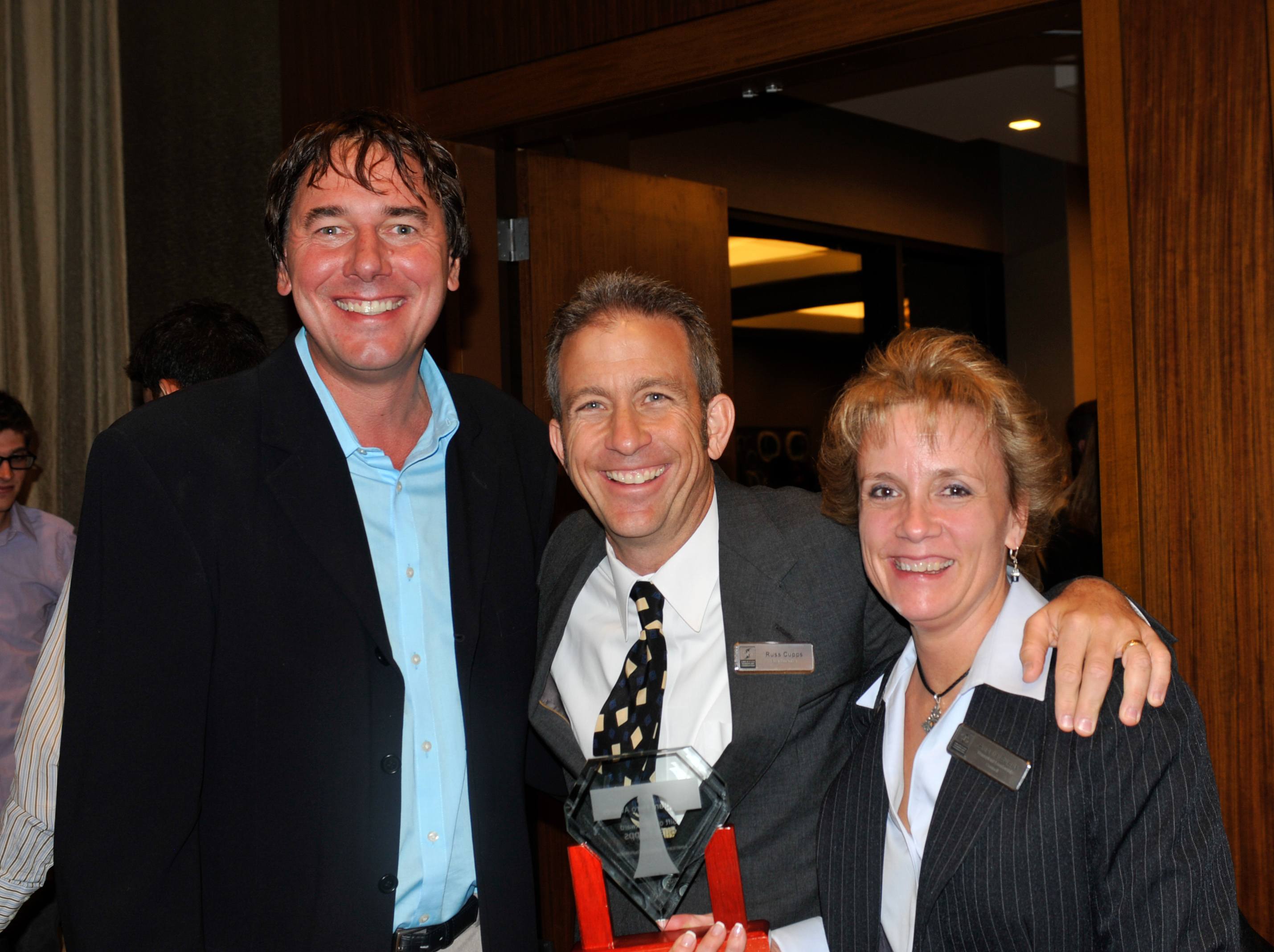 Dr. Tom Bak, left, with honoree Russ Cupps and Angela Cupps