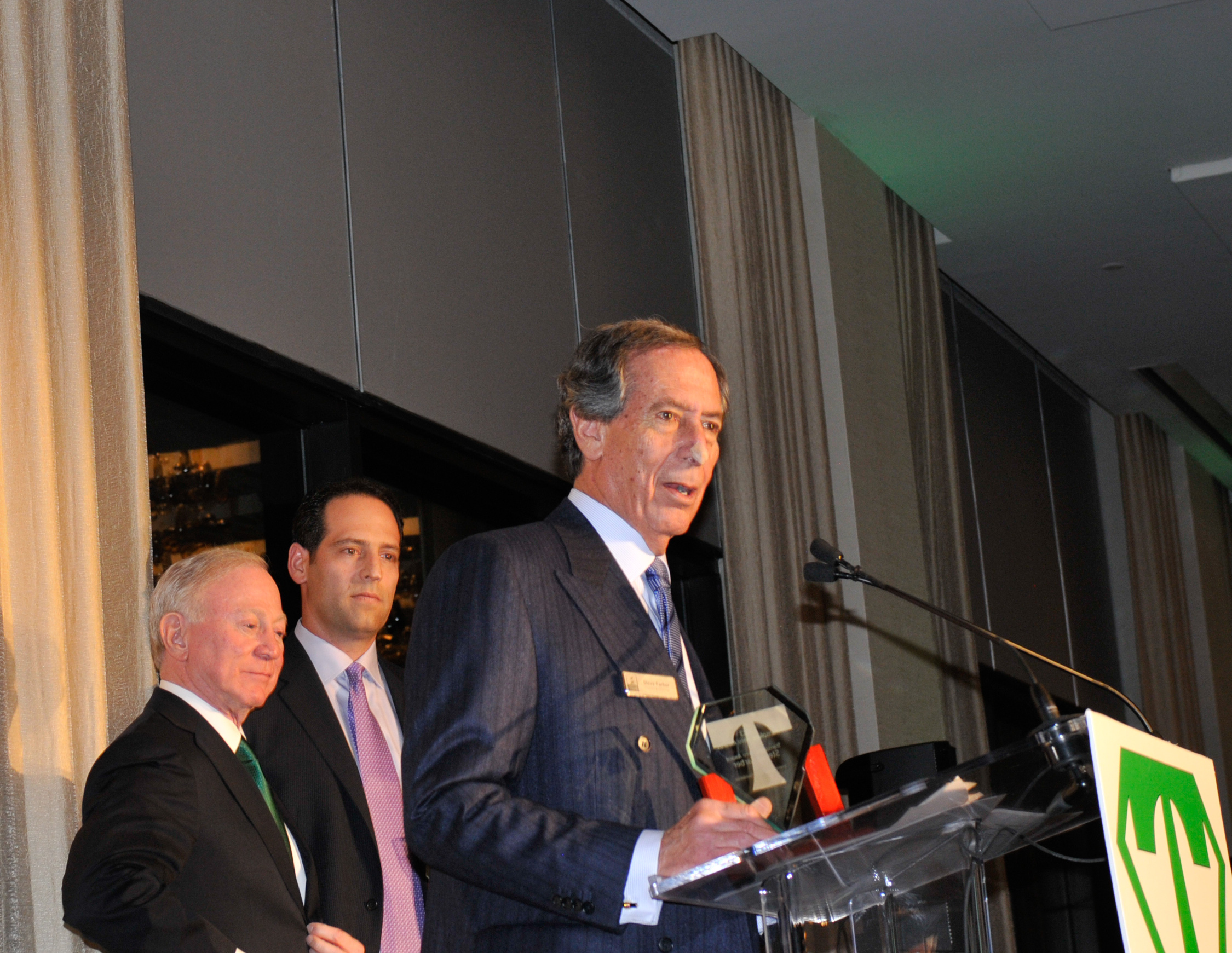 Steve Farber thanks his family, as Larry Mizel and son Gregg look on