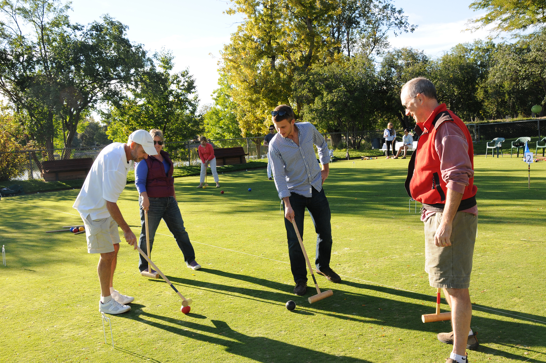 James Creasey is teaching the players how to play croquet