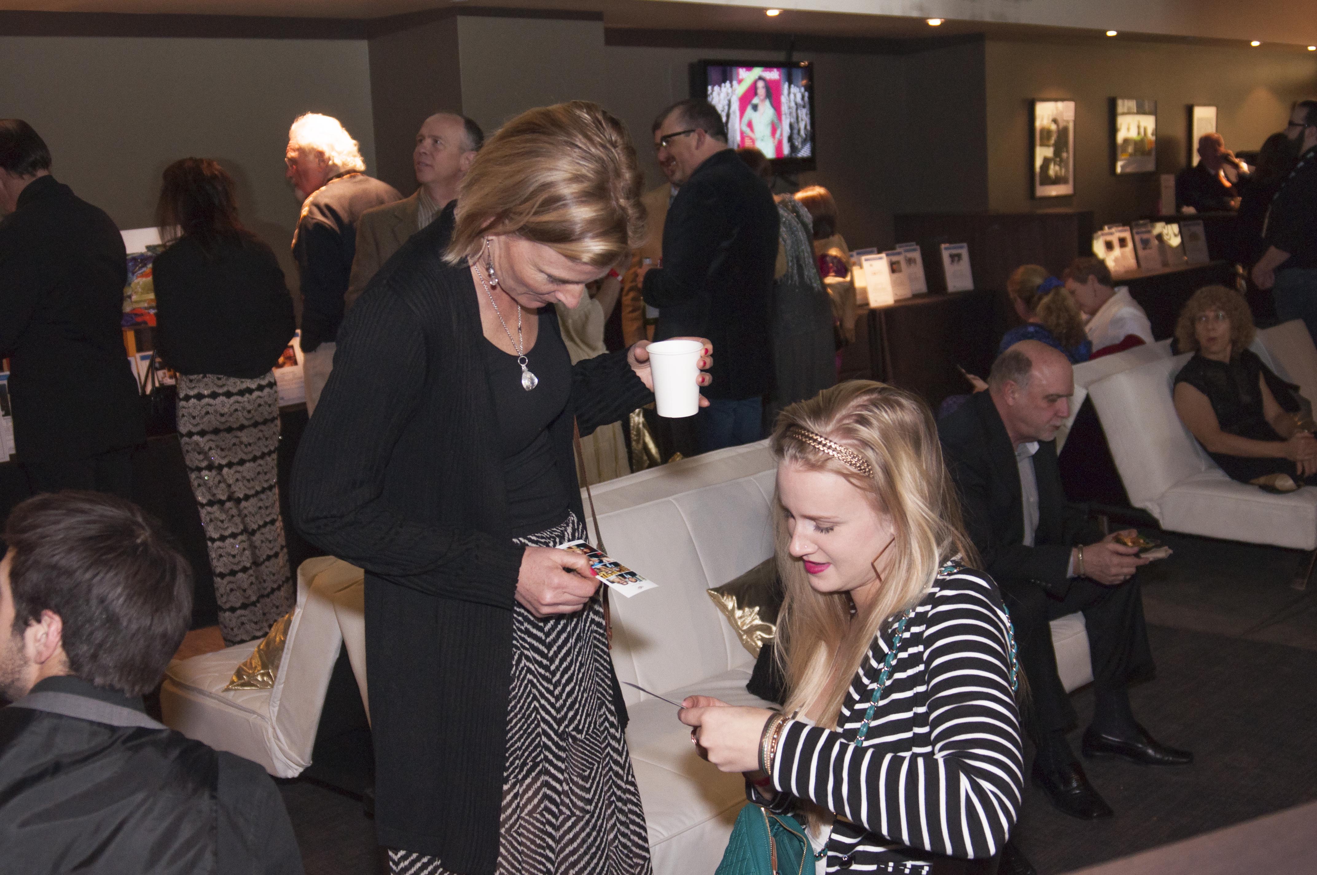 Guests check their photo booth images