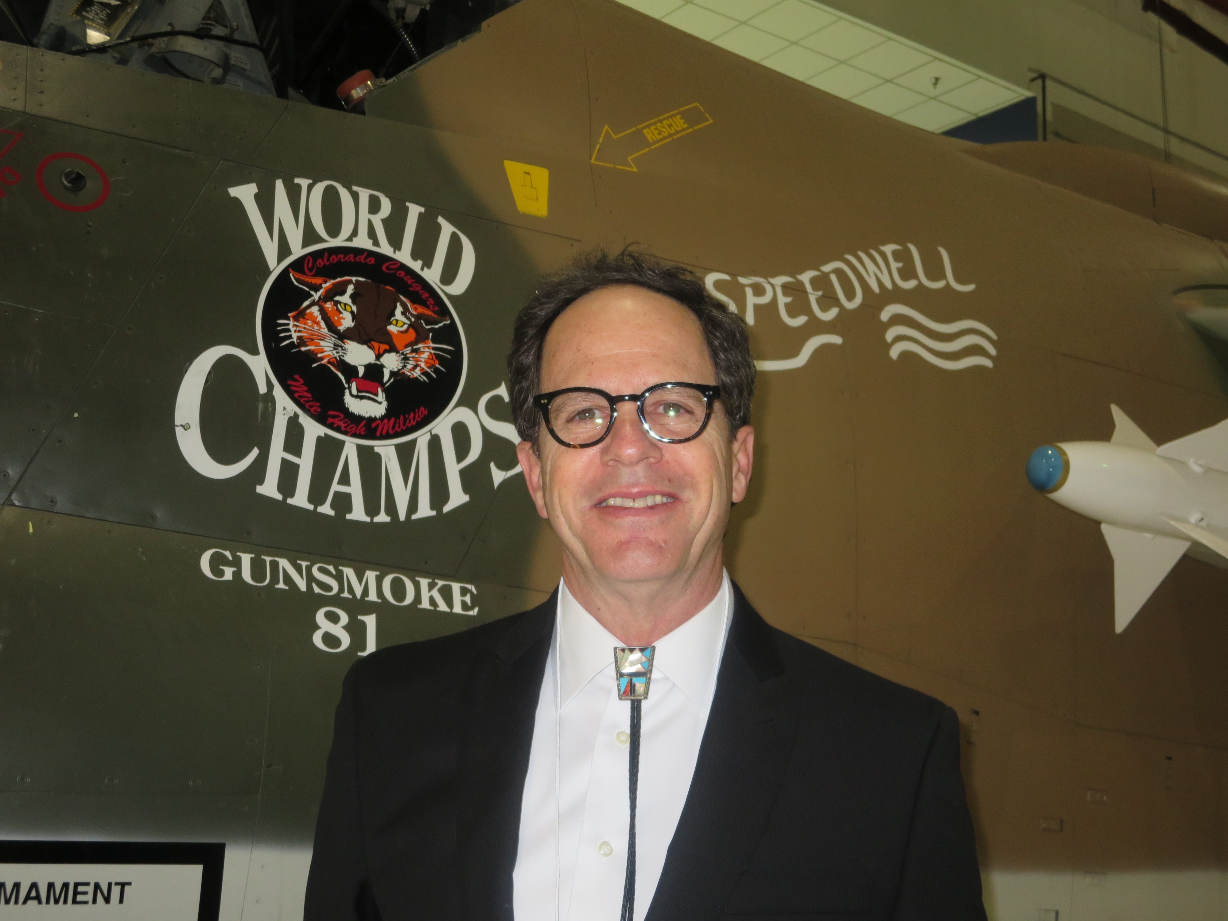 Alex Strickland standing in front of plane he flew from 1983-1992