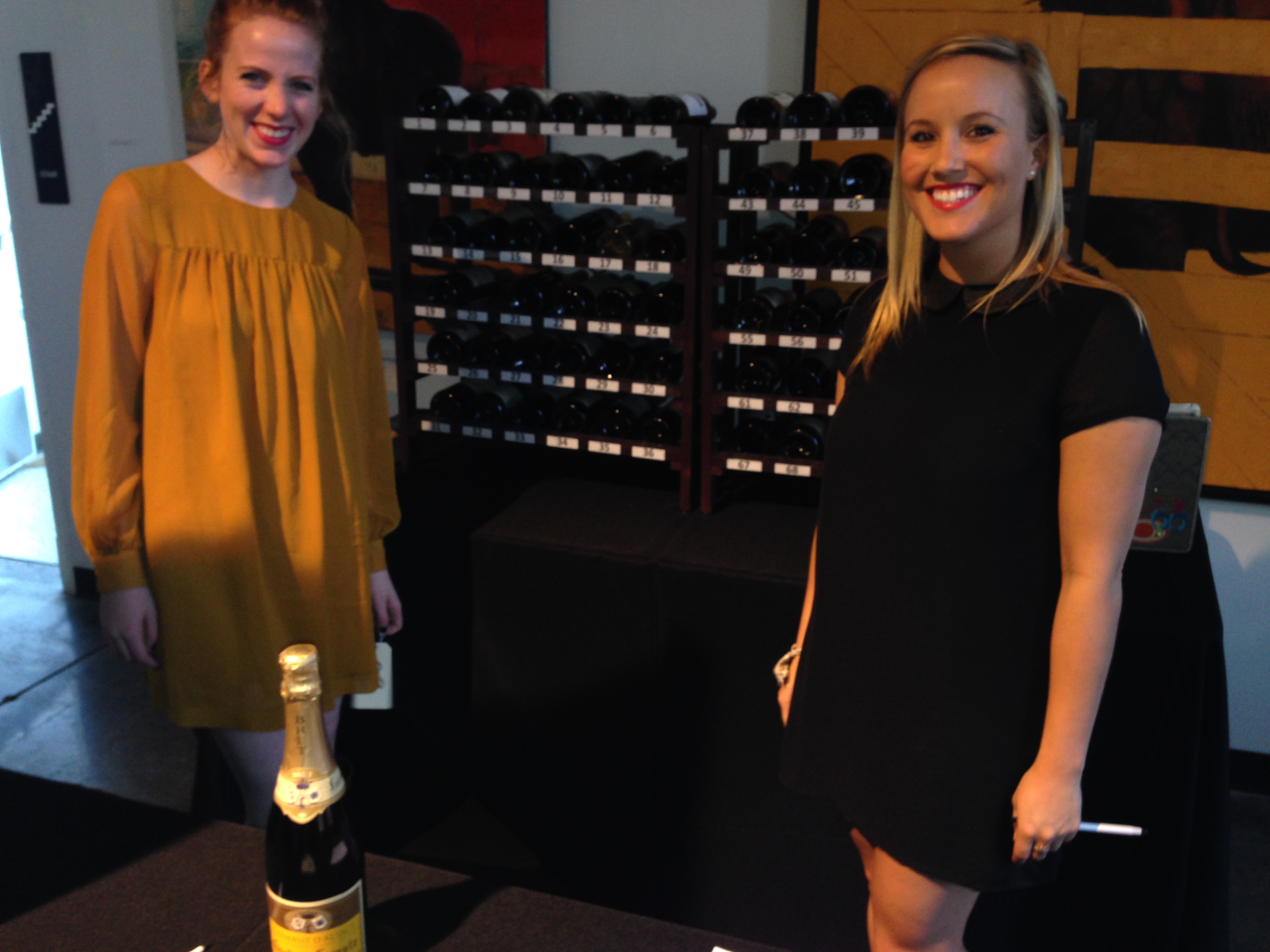 Lindsey Ritter and Morgan Fierno with the Wall of Wine display