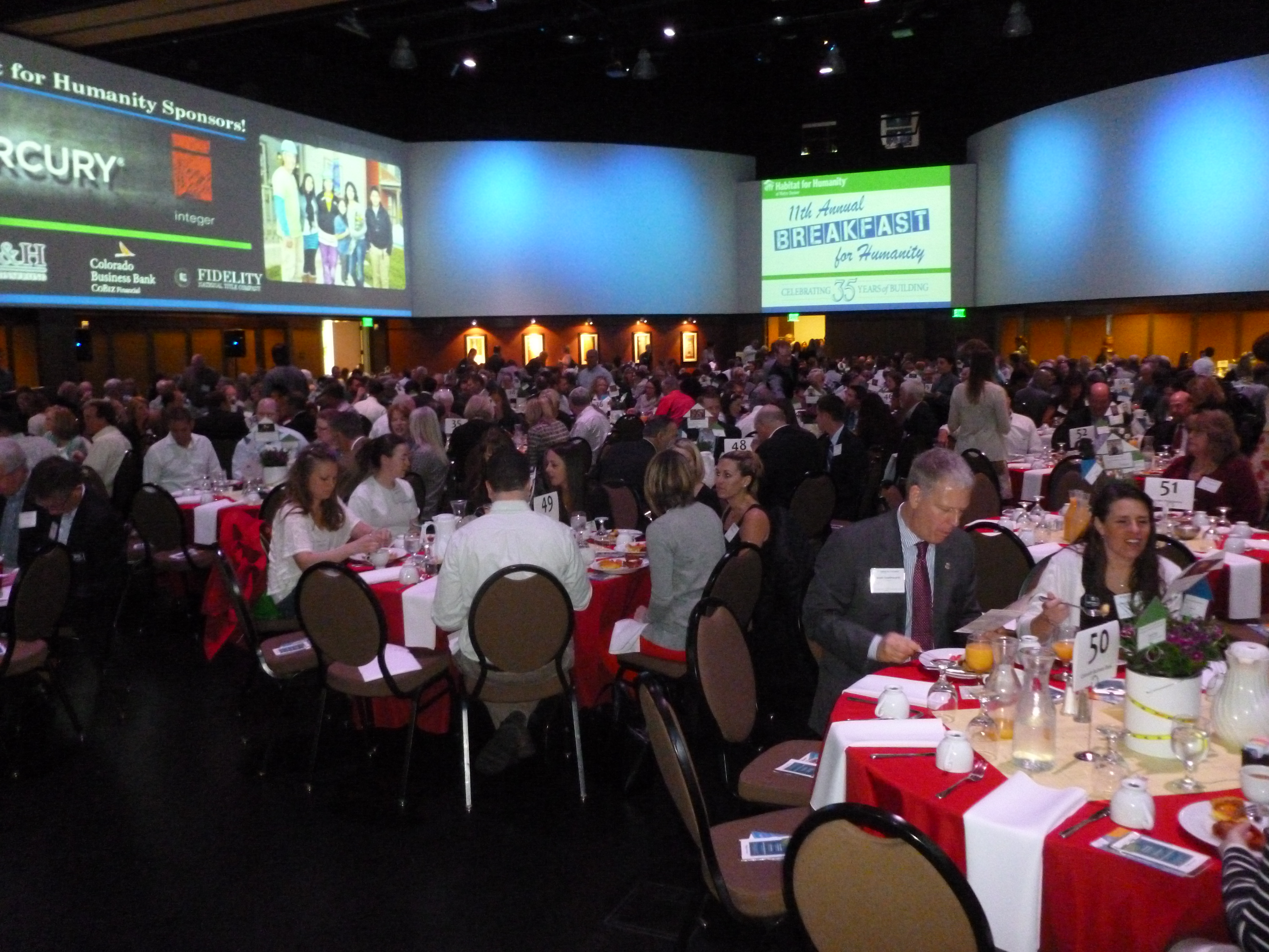 The crowd of nearly 700 enjoys a sit-down breakfast from Footers Catering.