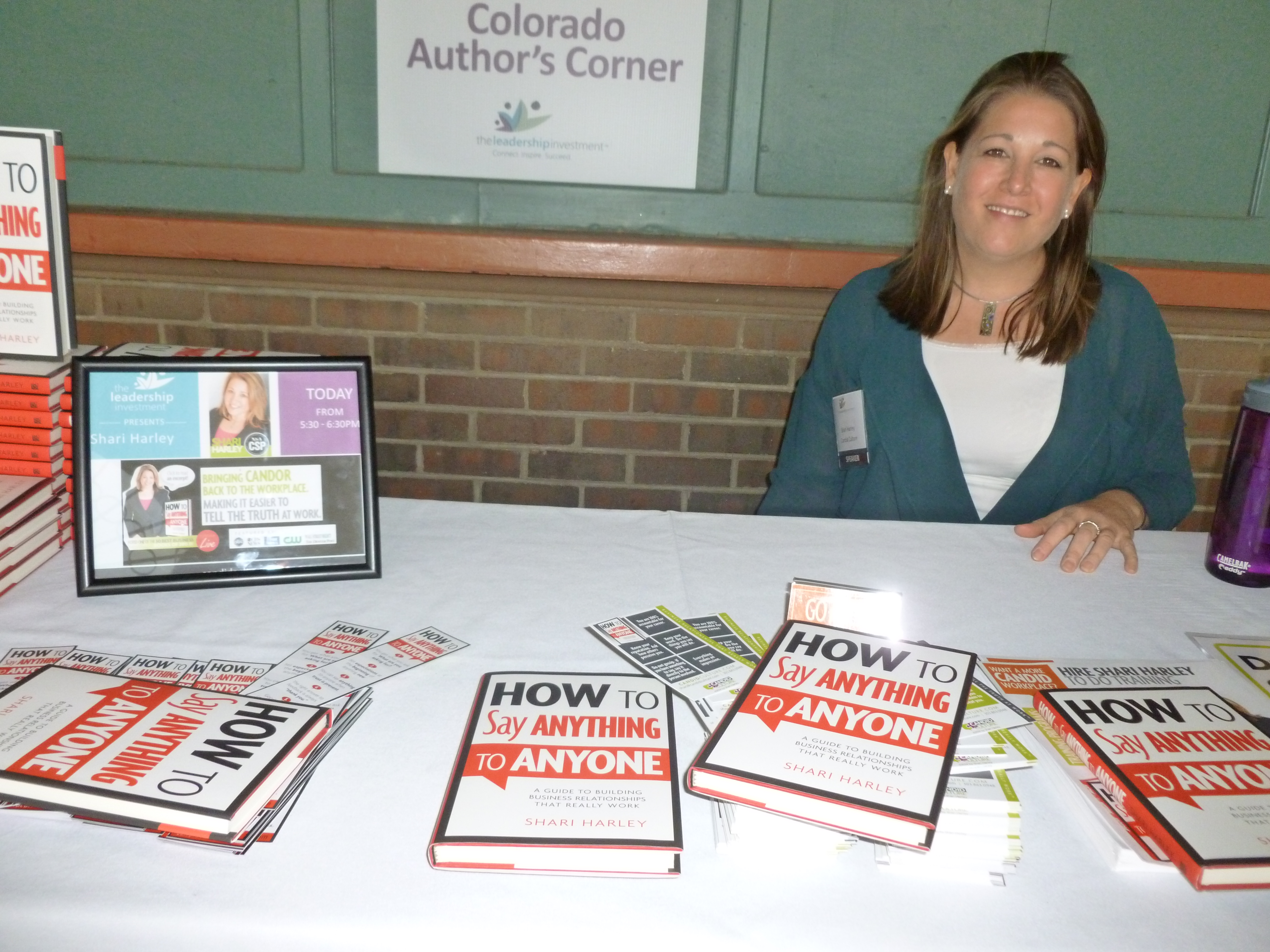 Speaker-author Shari Harley readies copies of her book "How to Say ...