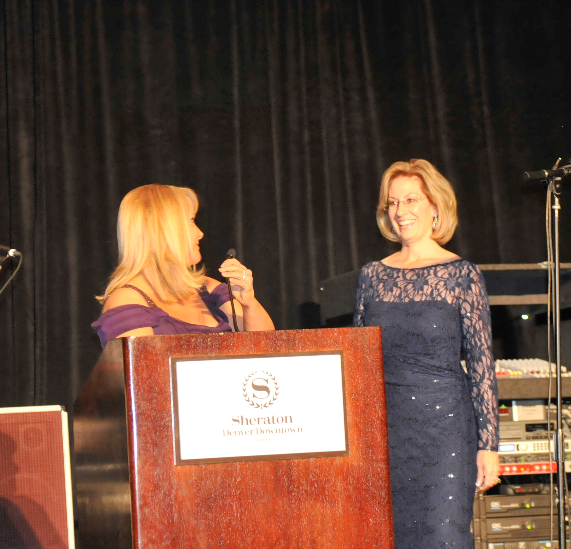 Angie Austin welcomes CEO Gina Berg to the stage