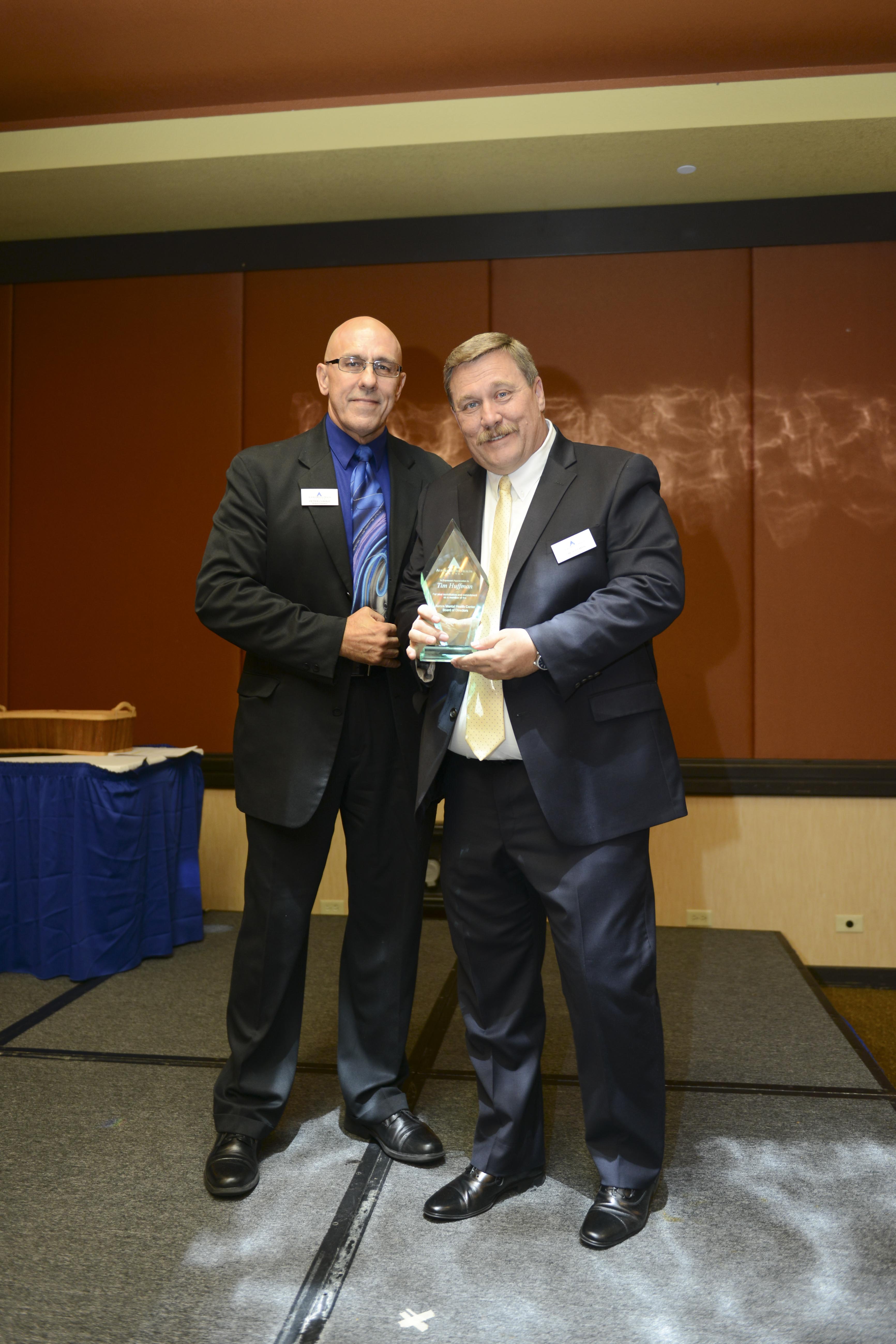 Tim Huffman, retiring board member, receives his award from Peter ...