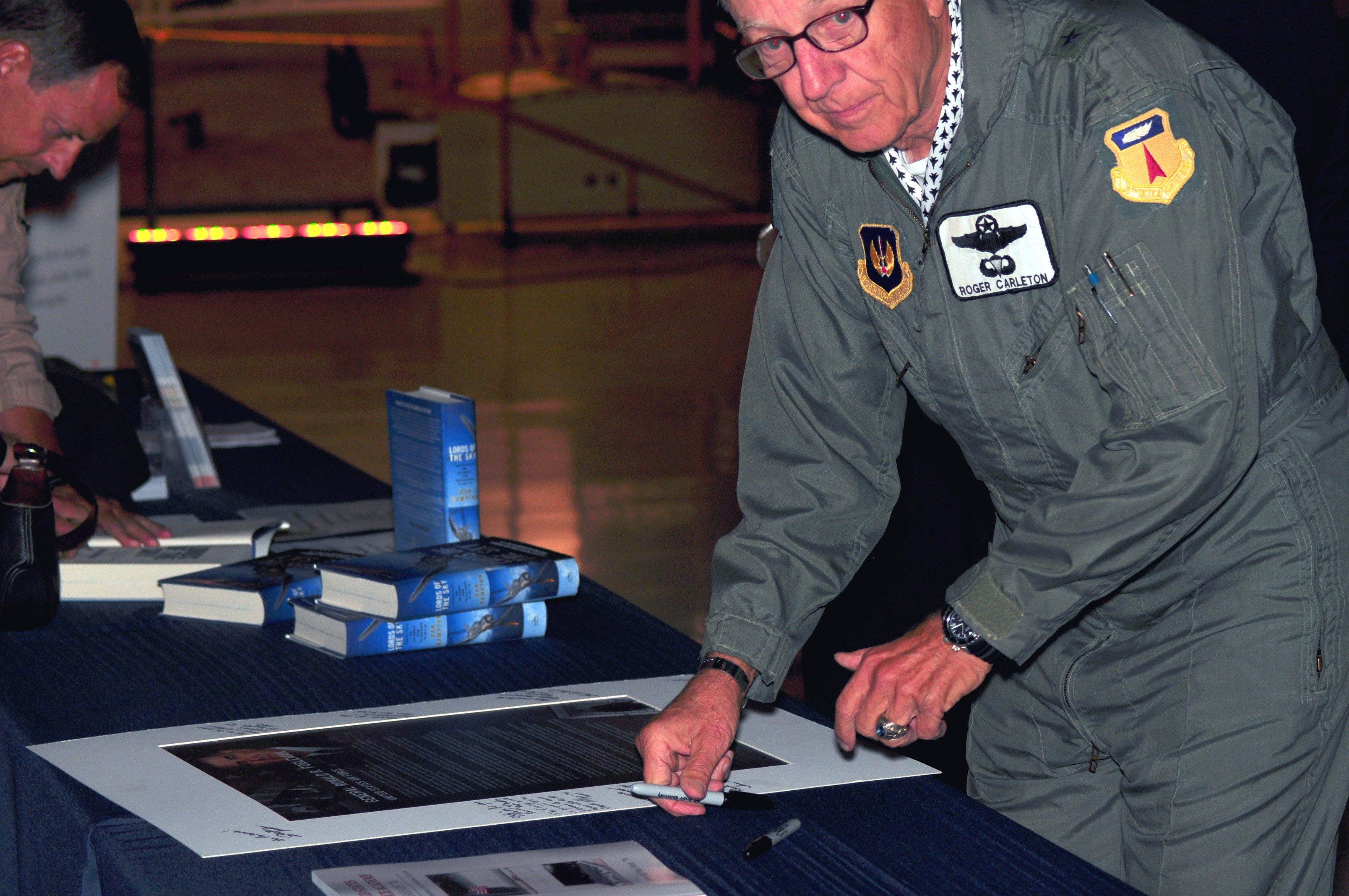 Brig. Gen. Roger Carleton signing poster for Gen. Fogleman