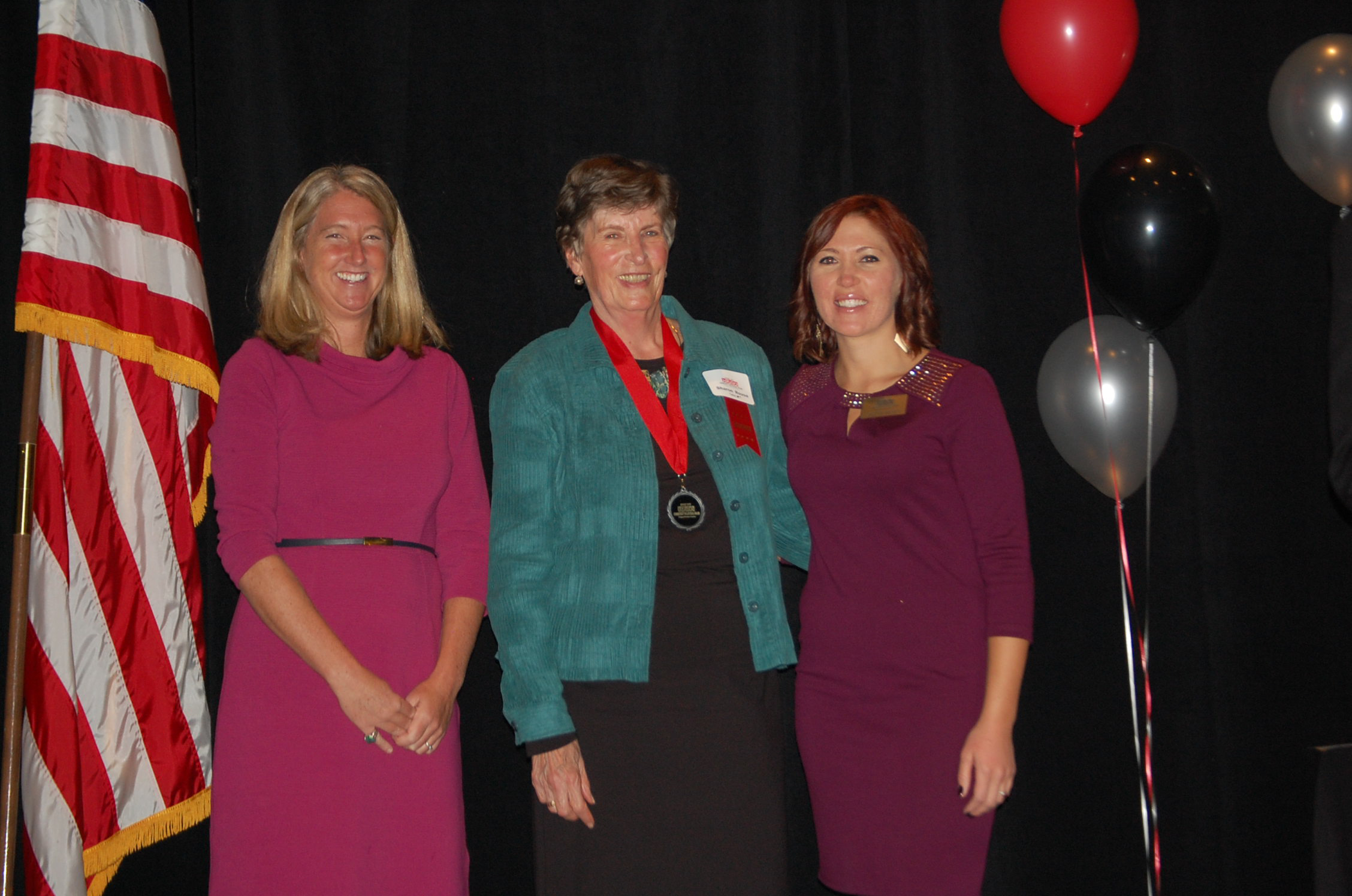 Cary Kennedy and Jaclyn Wilmot with June's honoree Sharon Rouse, center