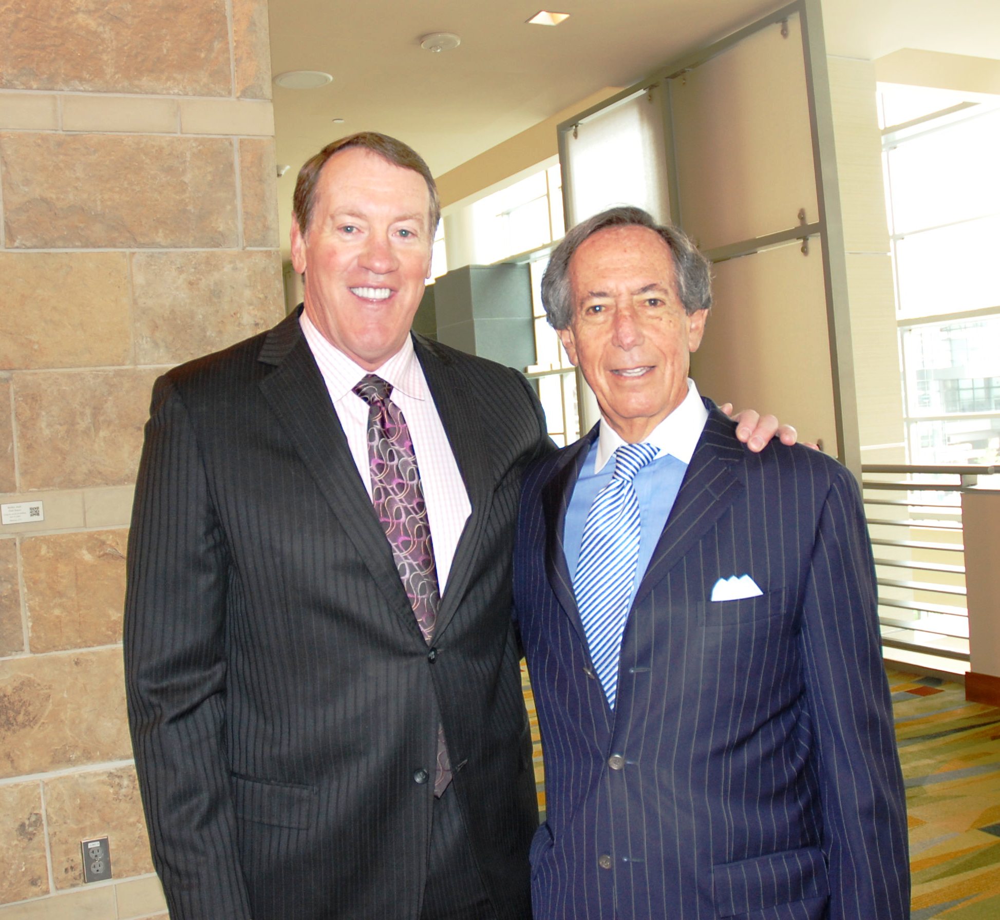 Emcee Dave Logan, left, chats with Steve Farber