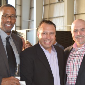 Checking out one of the raffle prize options (l to r): Richie Madison ...