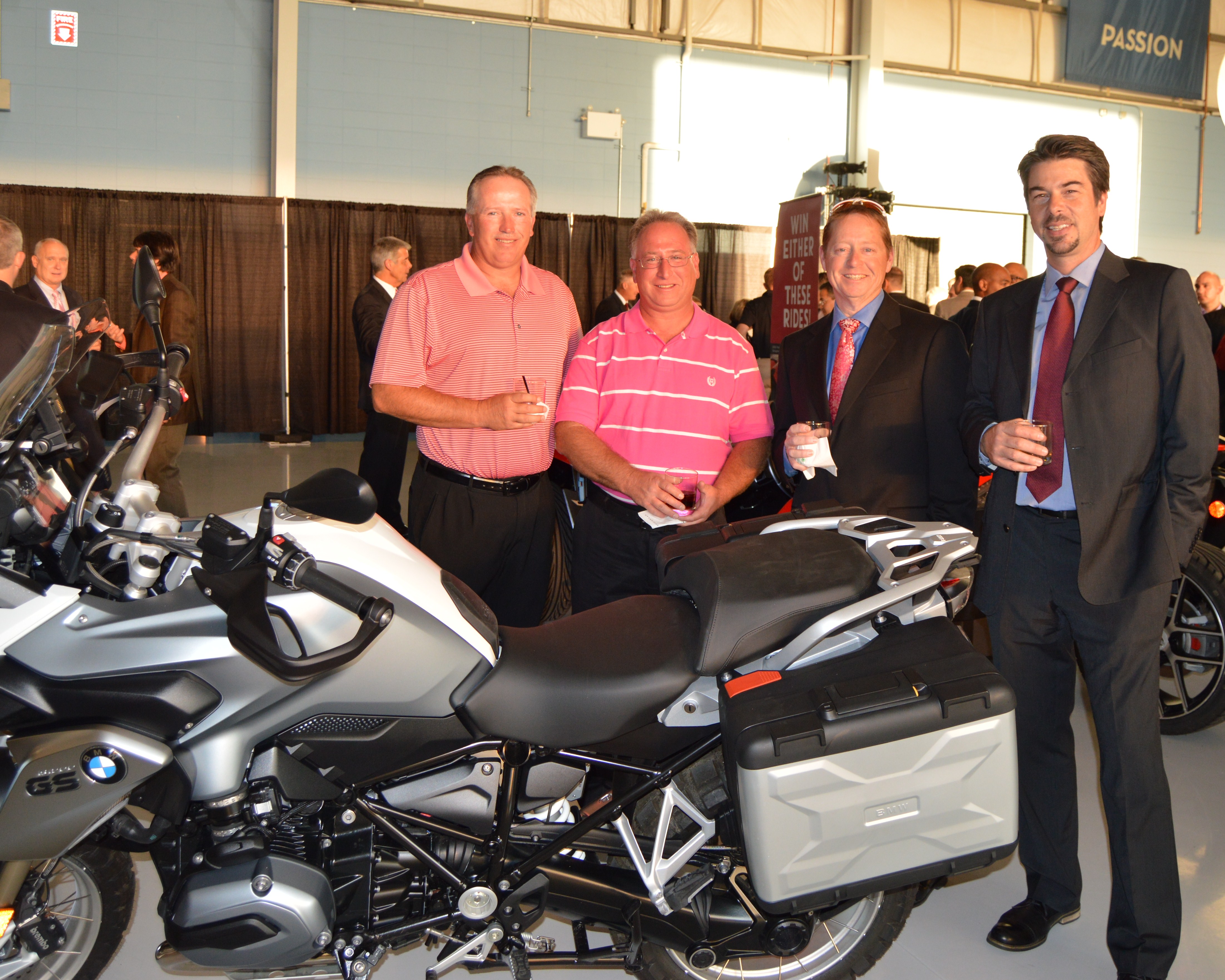 Checking out one of the raffle prize options (l to r): Richie Madison ...