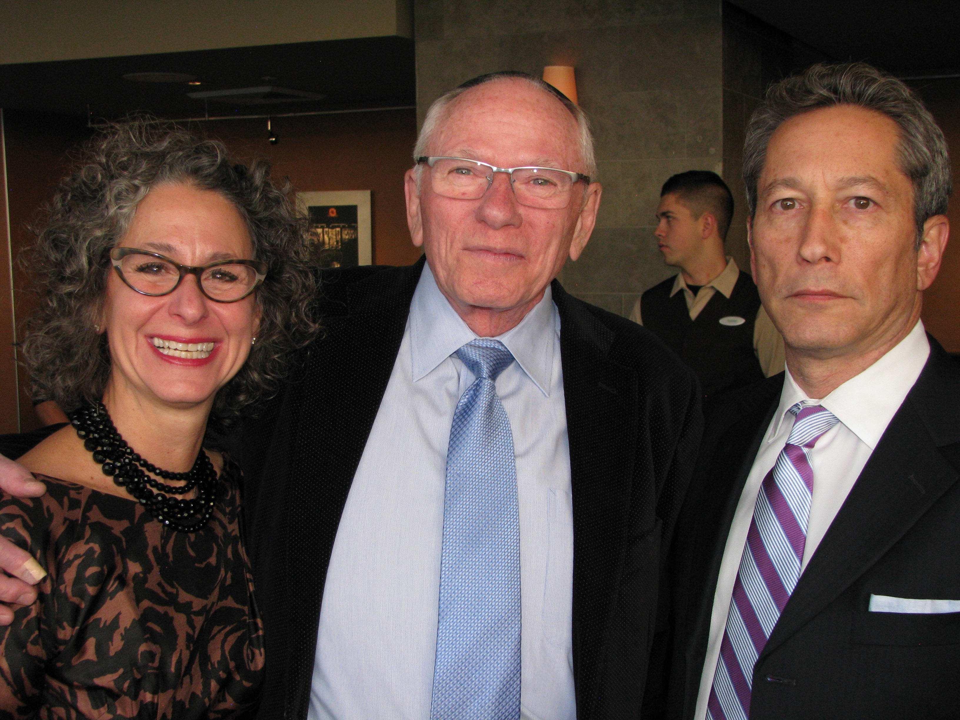 Susan Kramer, left, talks with Brett Kramer and Steve Abelman