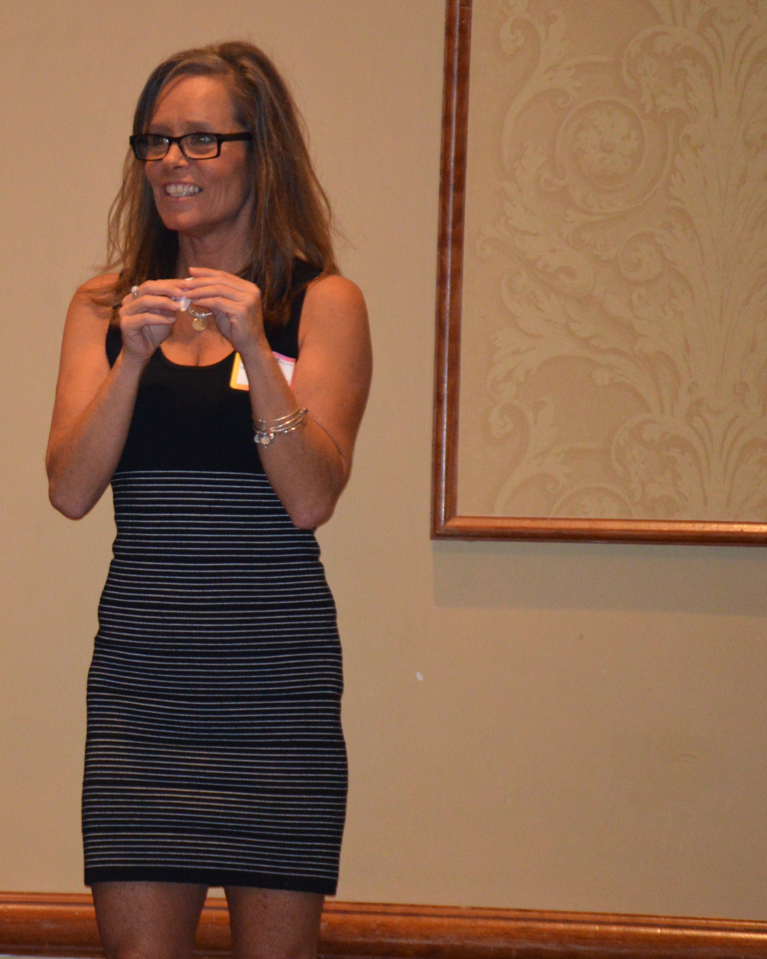 Teri Smith watches spirited bidding on Broncos-Patriots tickets.