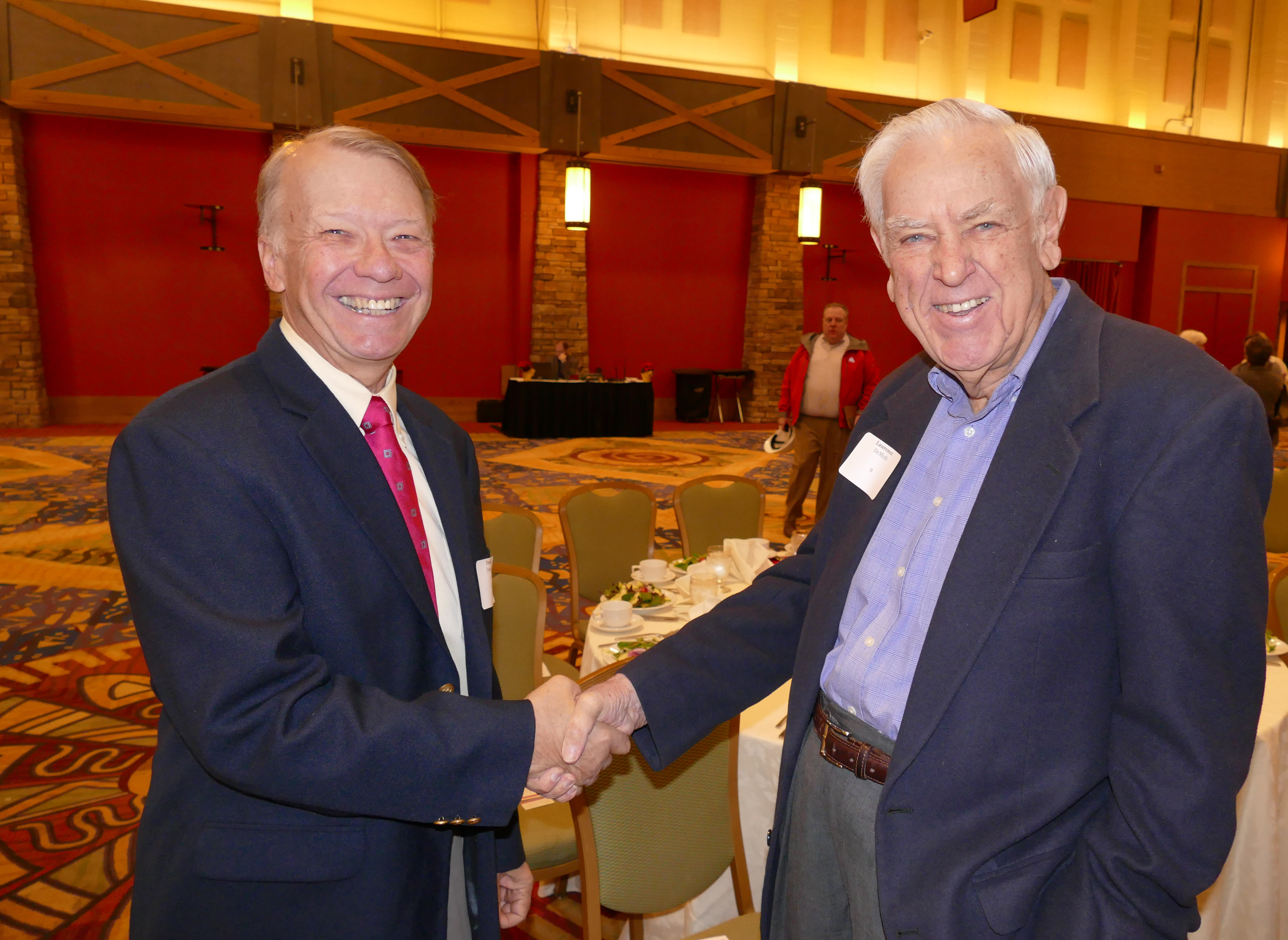Honoree Frank Doerger shakes the hand of Laurence DeMuth, a past honoree