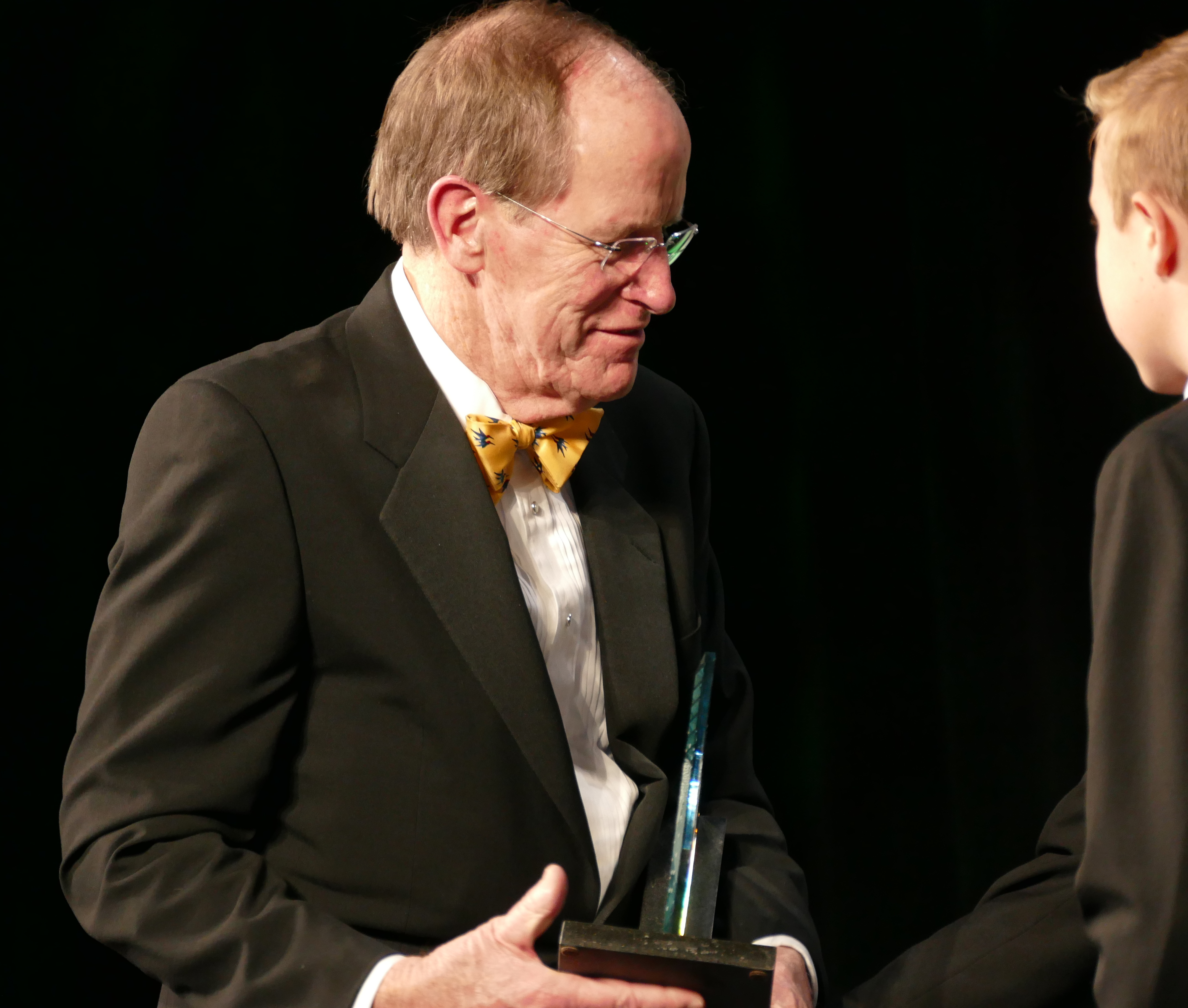 Ron Williams proudly takes his Laureate award from the stage