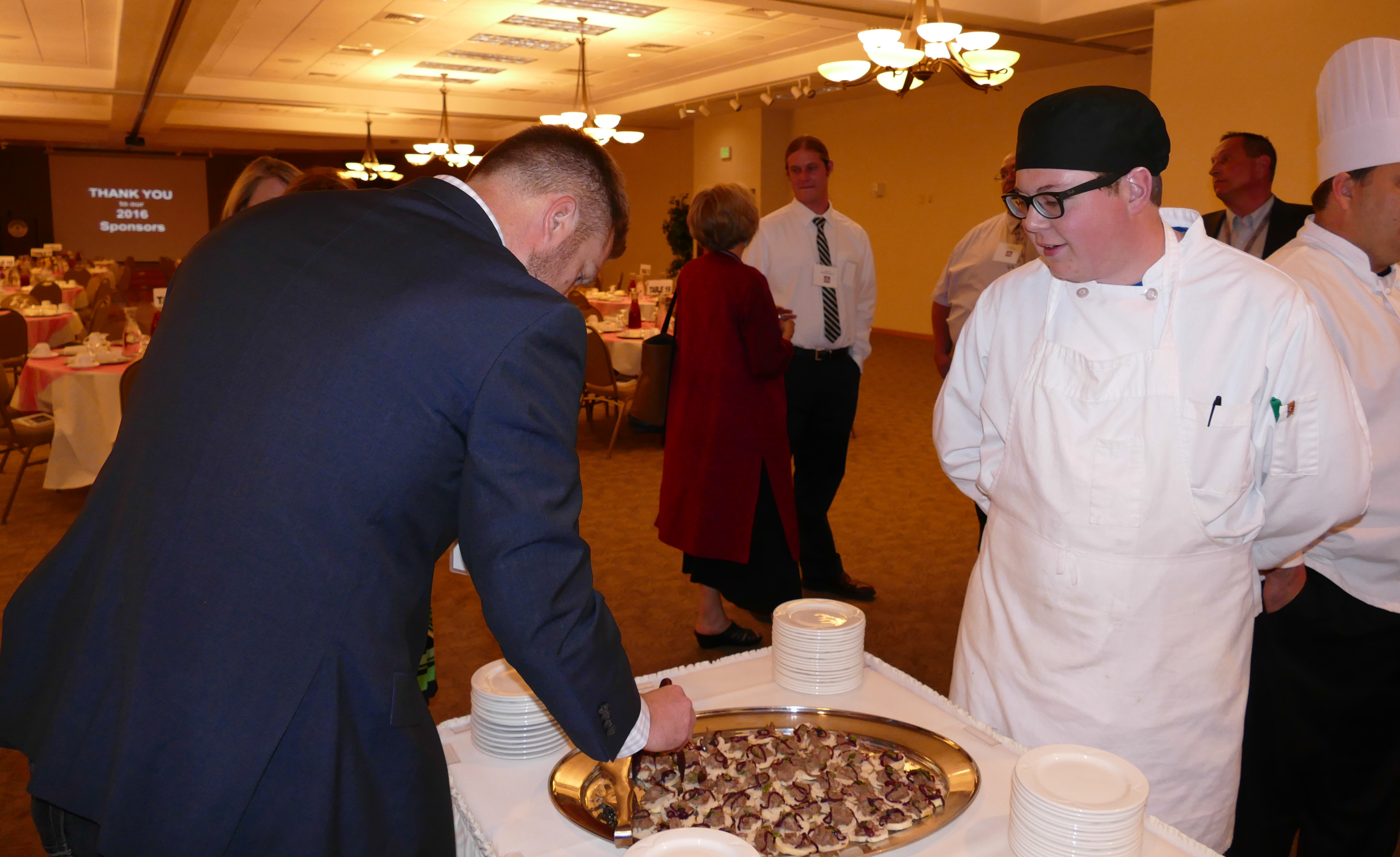 Chef Will Collins tells a guest about the delicious appetizers