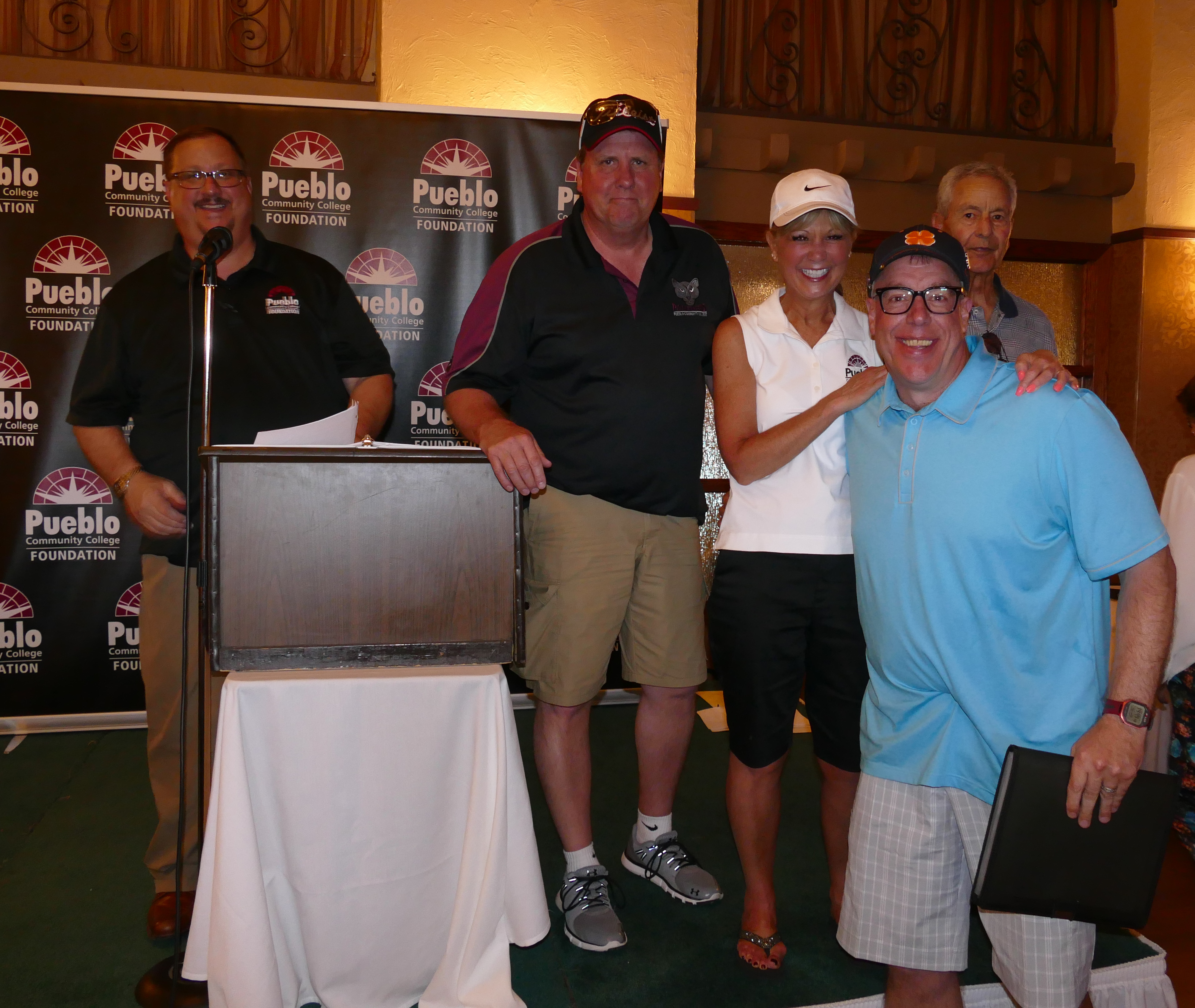 Ron Francis, in blue shirt, accepts an award for his teammate, as Mike ...