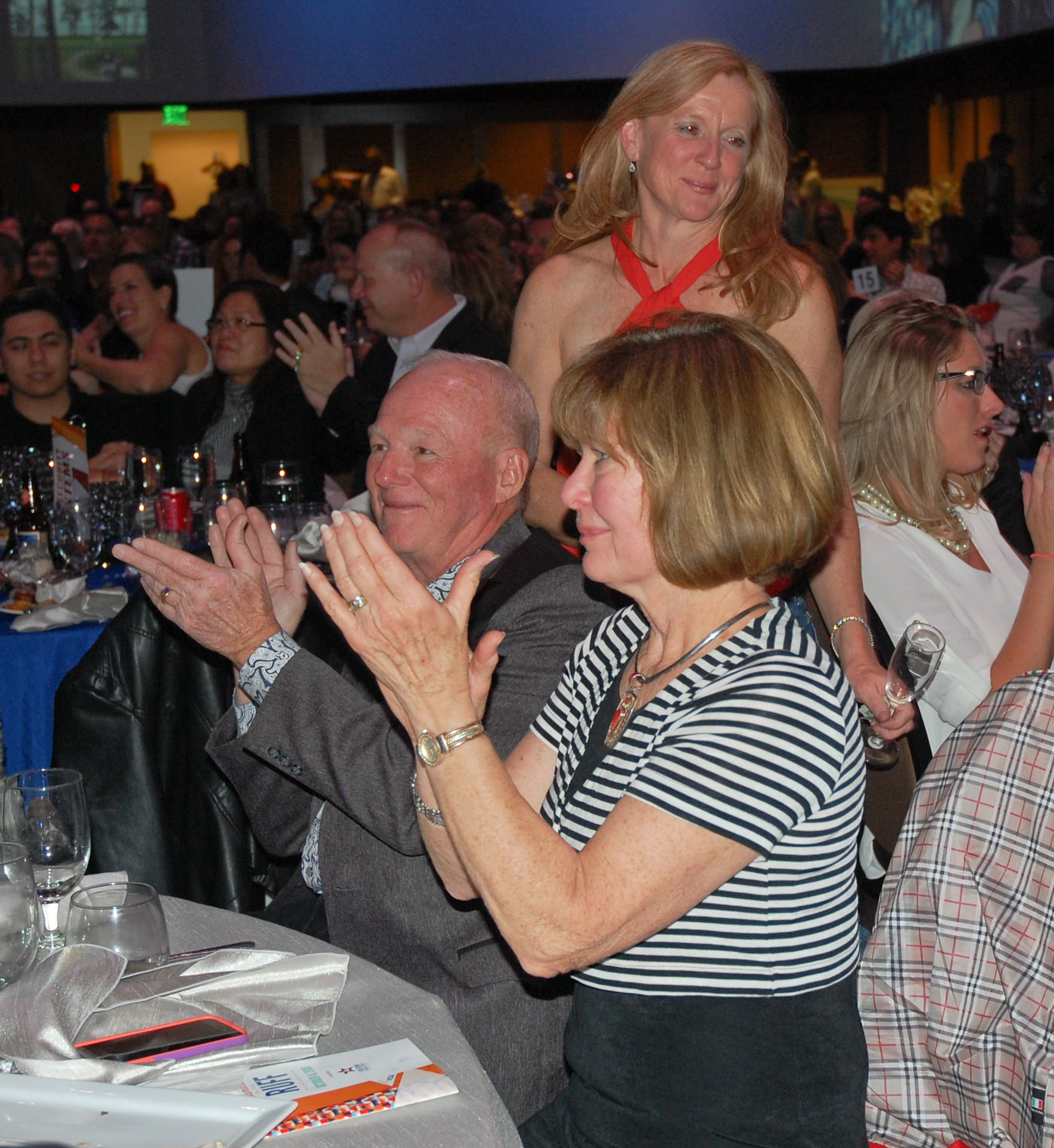Tom and Sharon Scanlon clap after the results of their donated Kauai ...