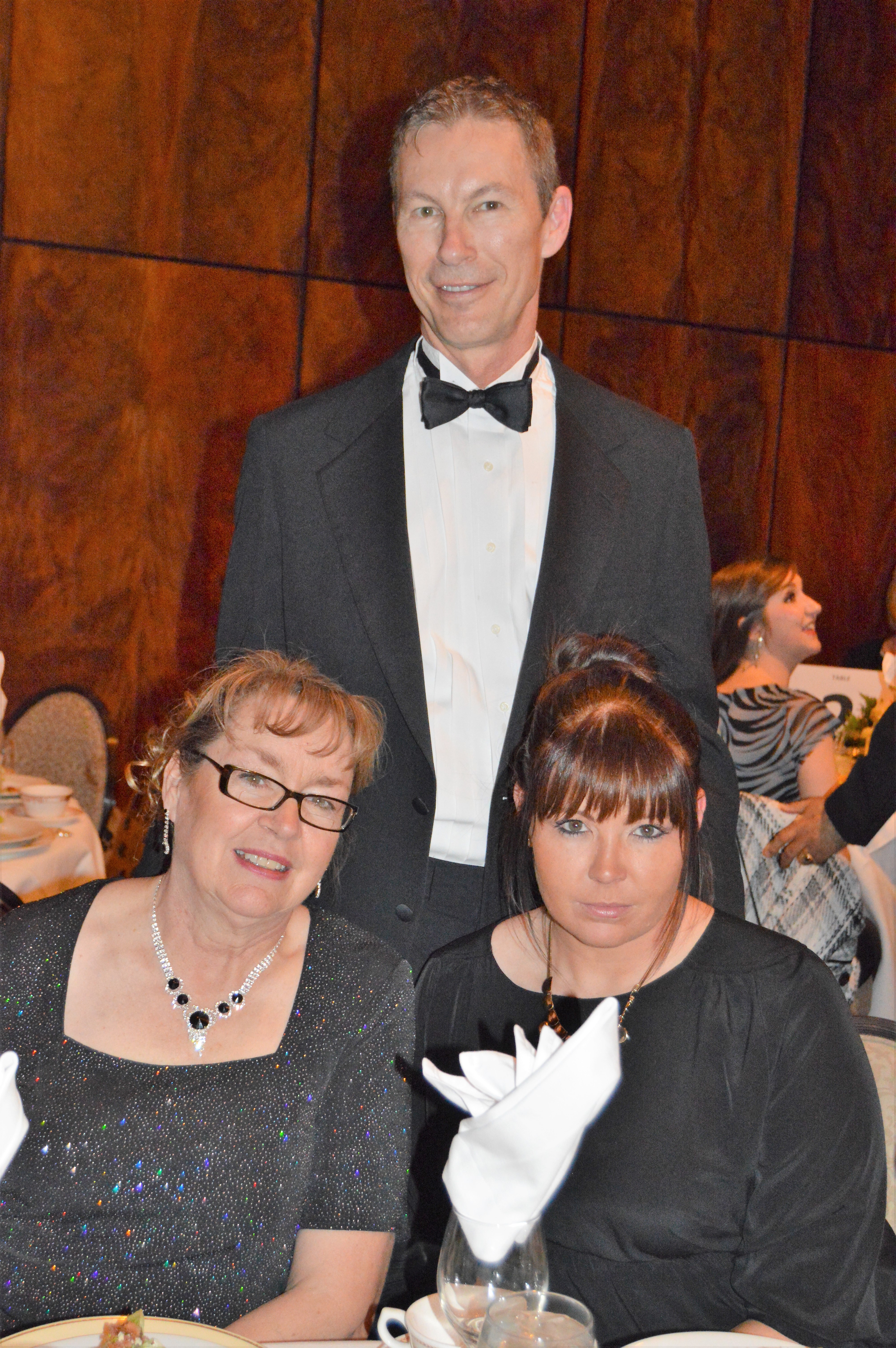 Seated: Robbie Aiken (left) and Kelly Aiken, with Neal Steinbrecher