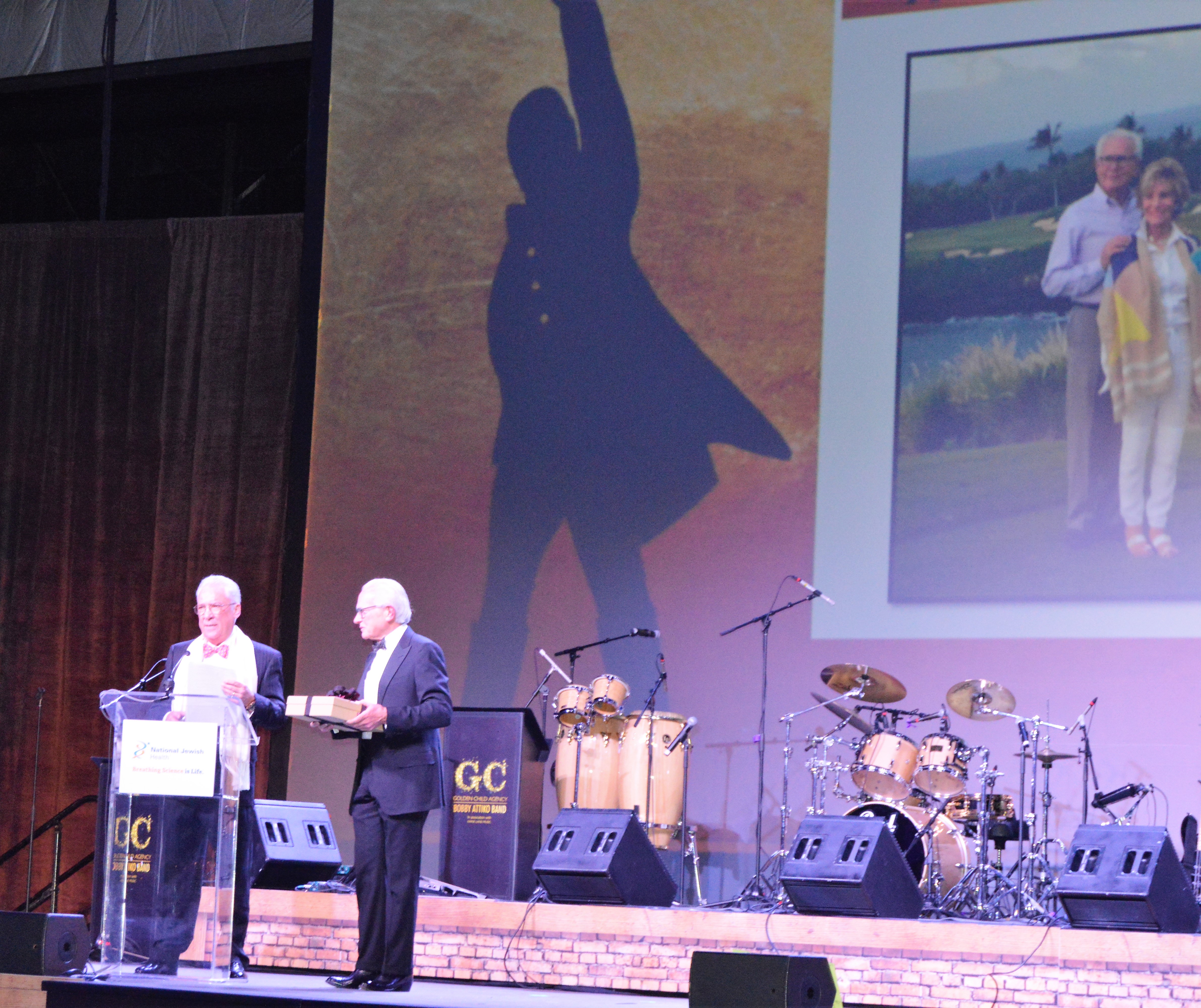 Honorary chairman Barry Hirschfeld (right) is honored on stage.