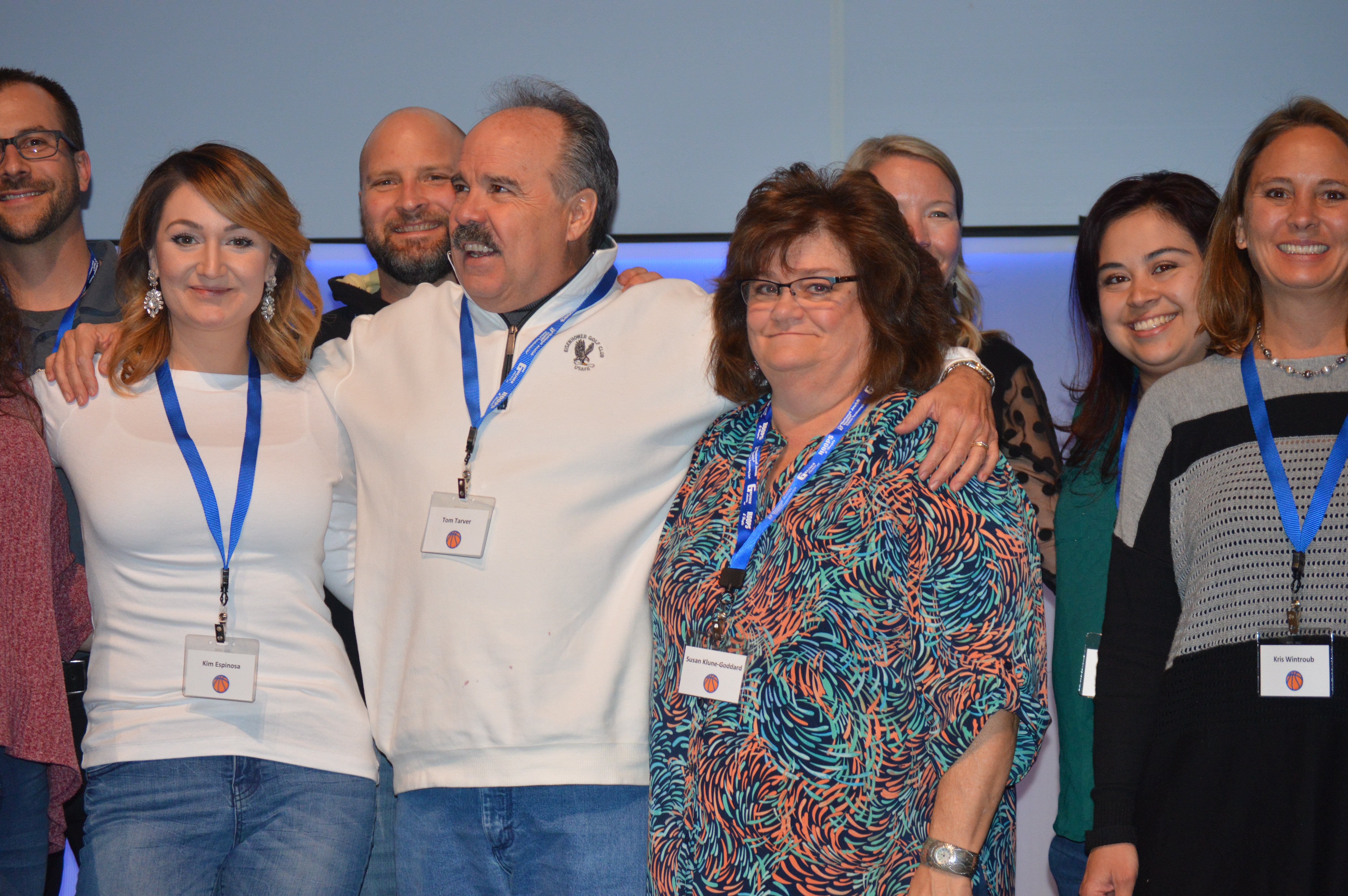 Tom Tarver, Susan Klune-Goddard and Greiner Electric teammates on stage.