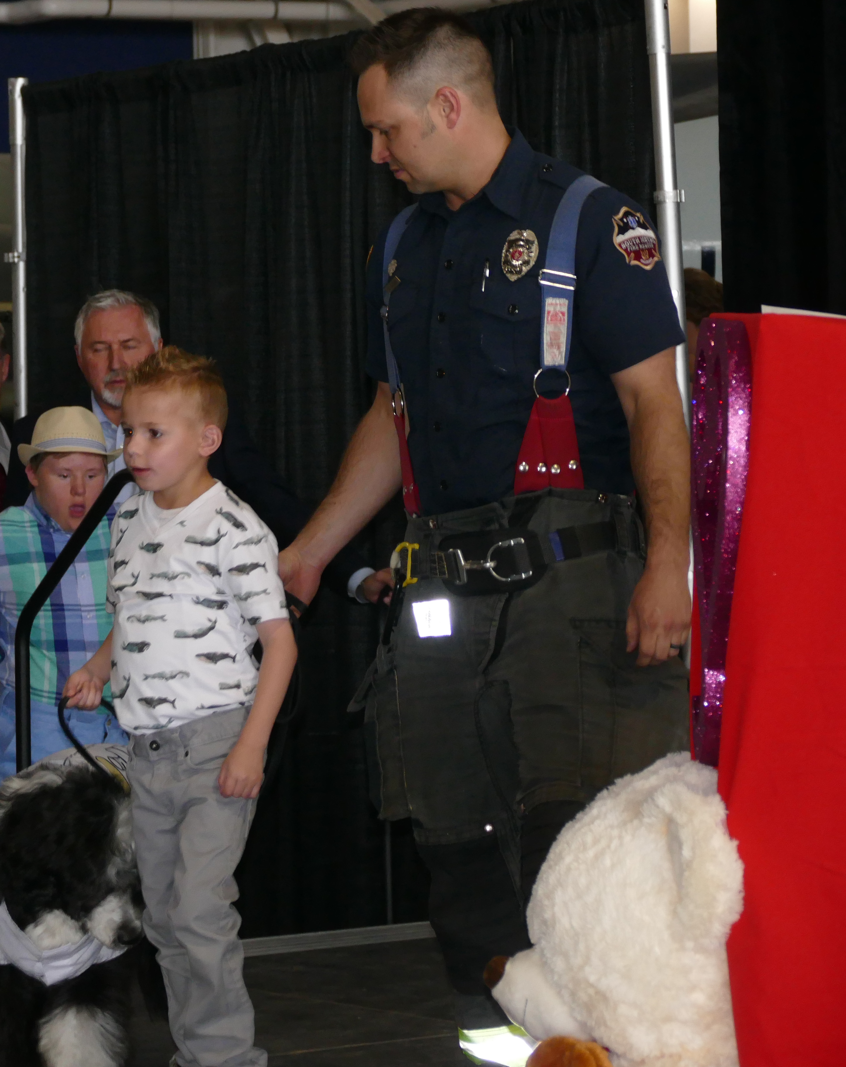 Xander, firefighter Matt Bovee and dog Popeye take the runway