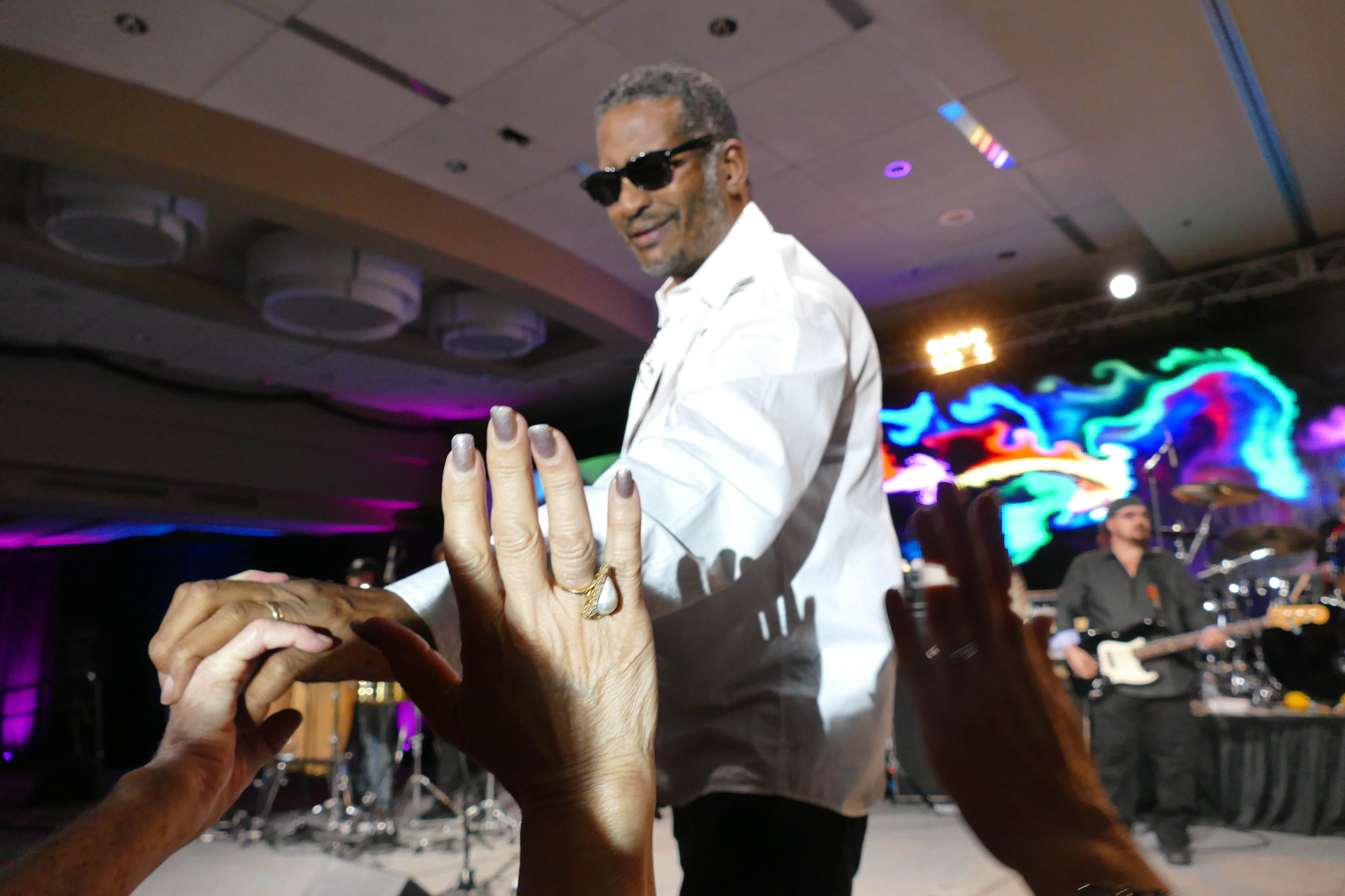 Greg Walker of Santana greets the audience