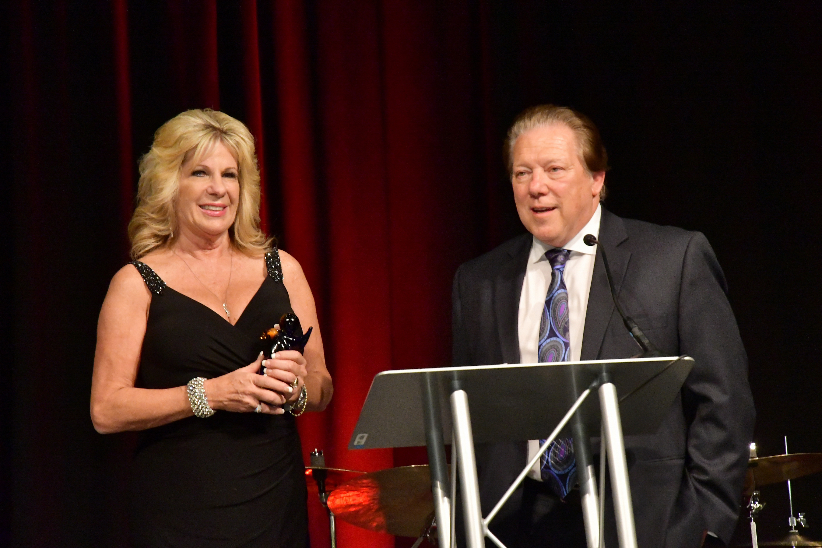 Terri and Al Fisher on stage accepting their honor (photo by Stevie ...