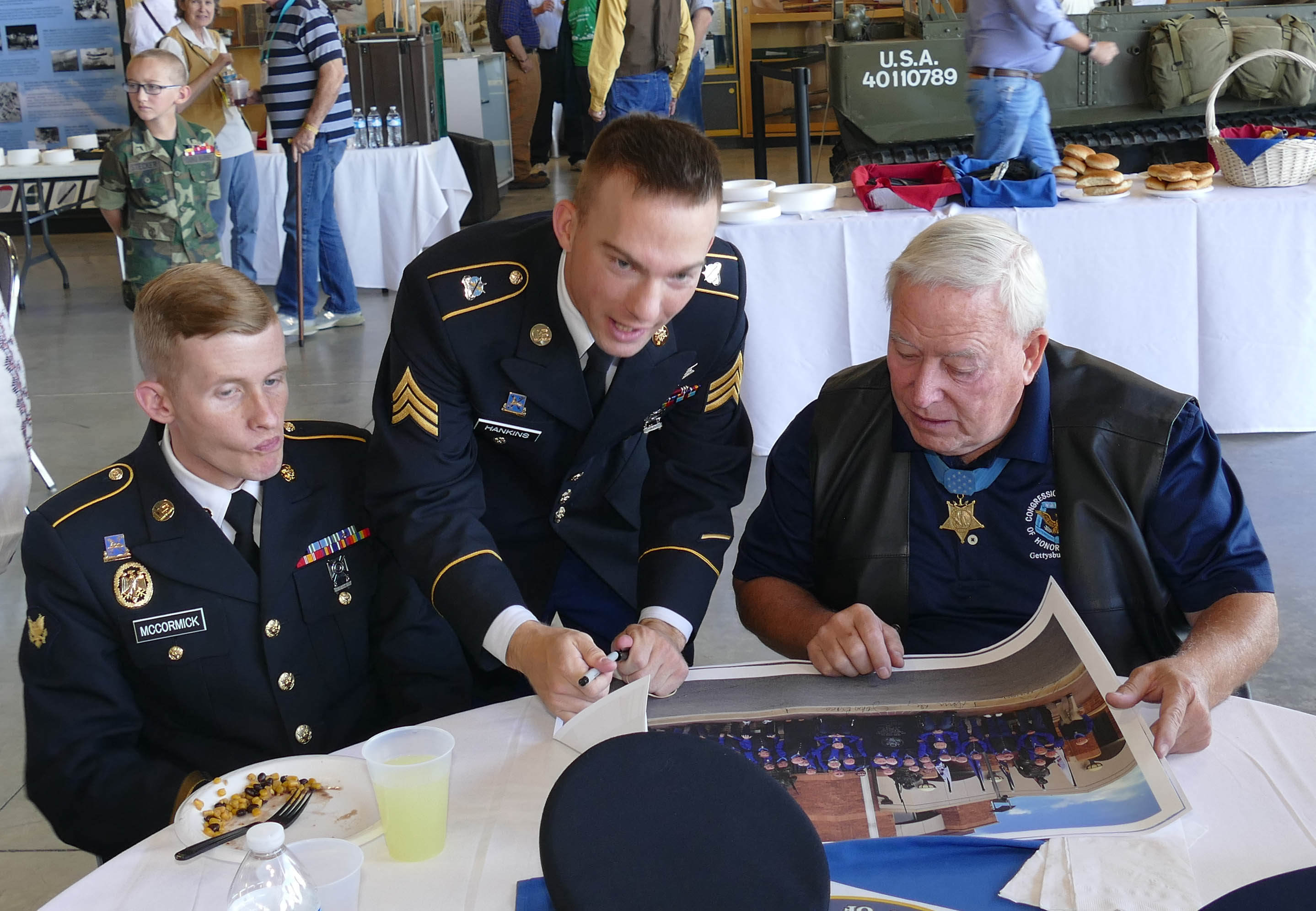 Recipient Don "Doc" Ballard signs autographs