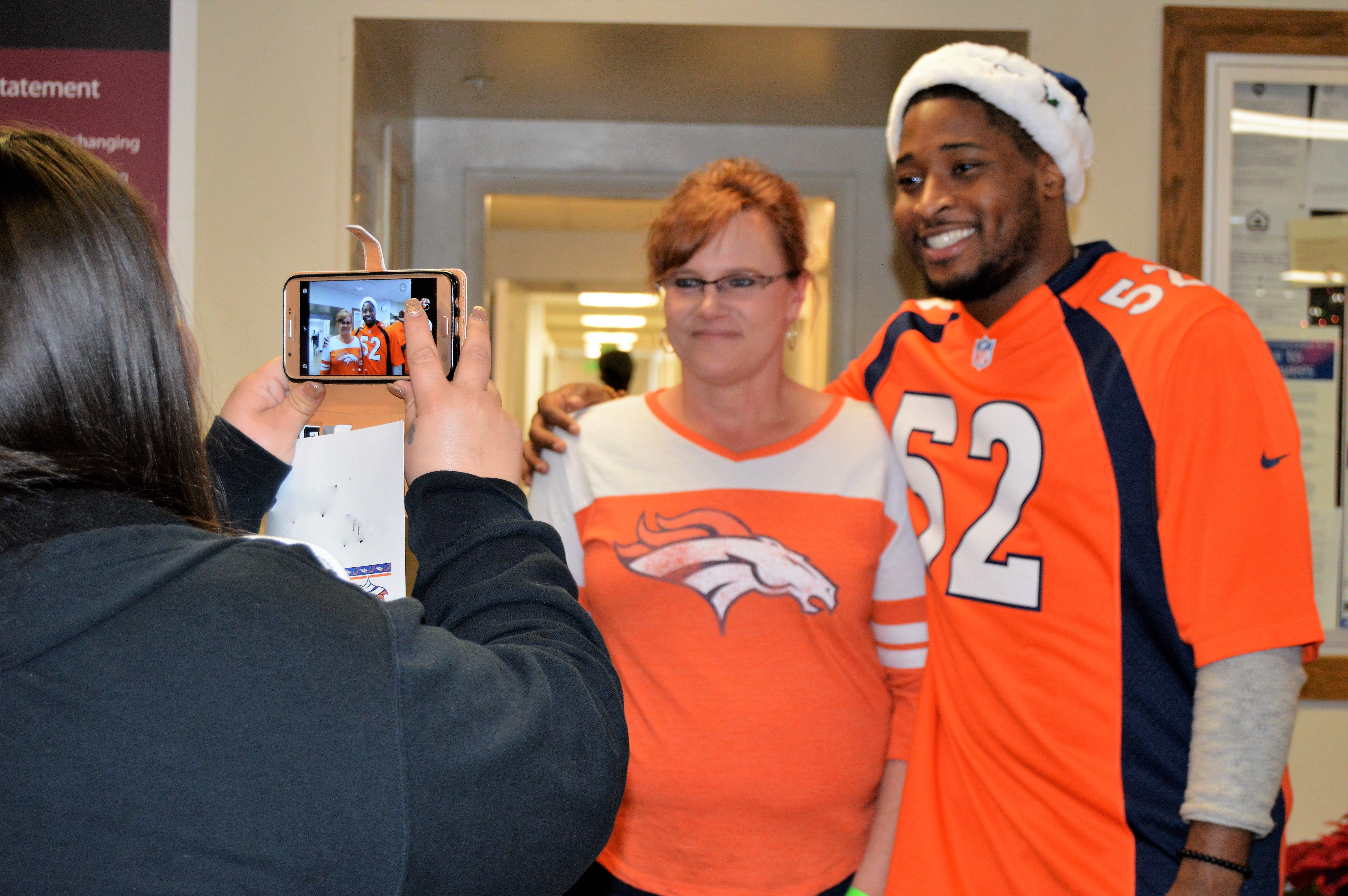 Posing with Broncos ILB Corey Nelson (52).