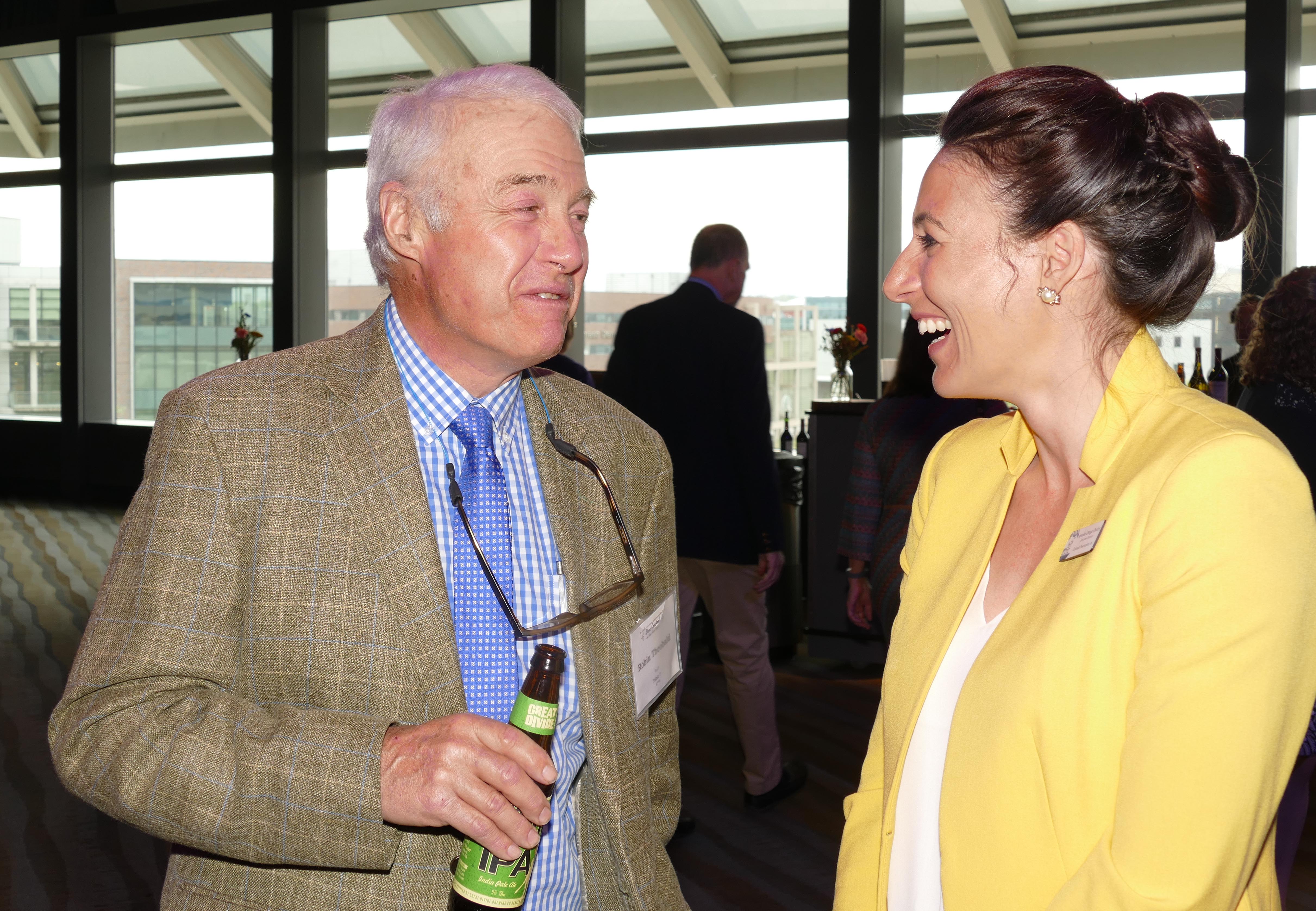 Board member Robin Theobald chats with Jennifer Orrigo Charles