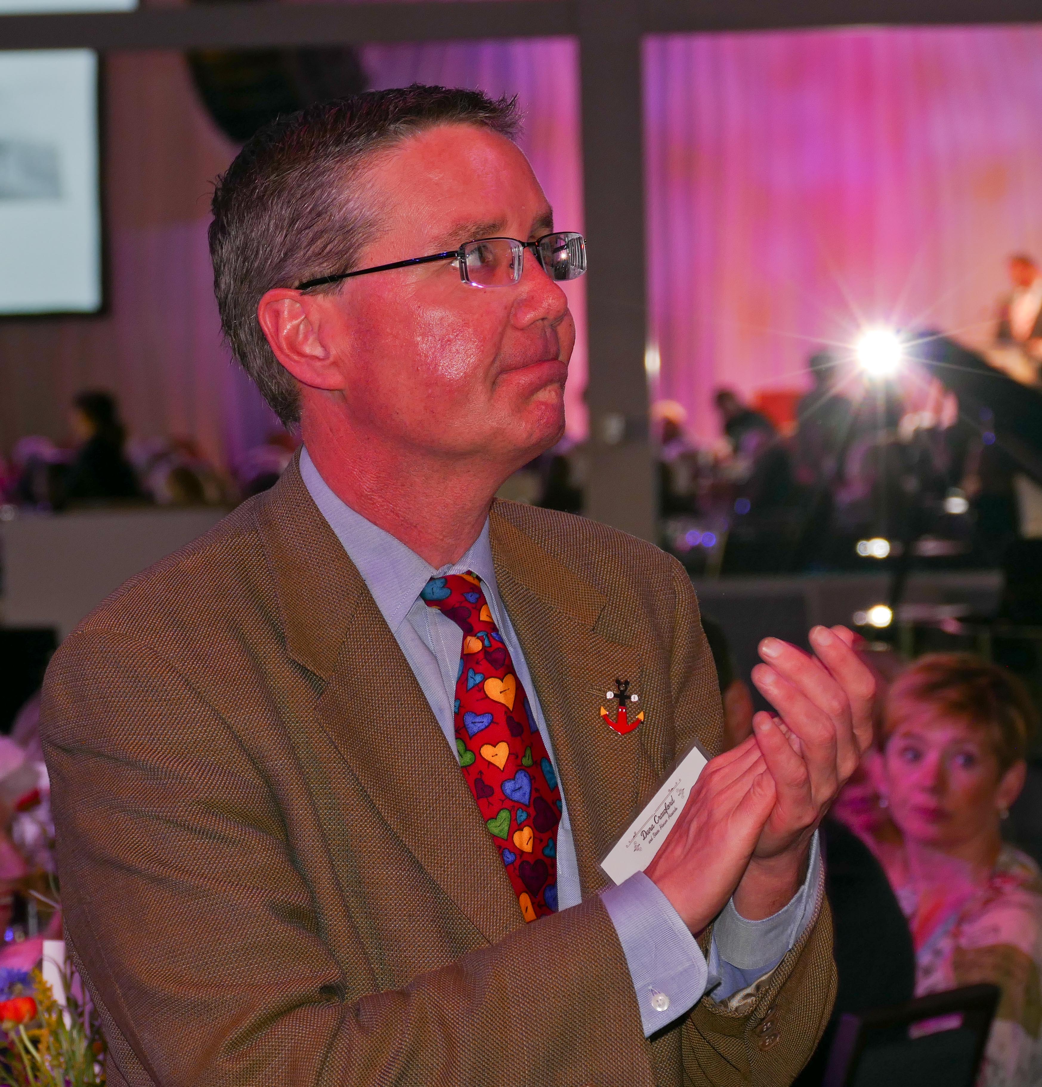 Brian Young of Colorado College stands to receive acknowledgement of ...