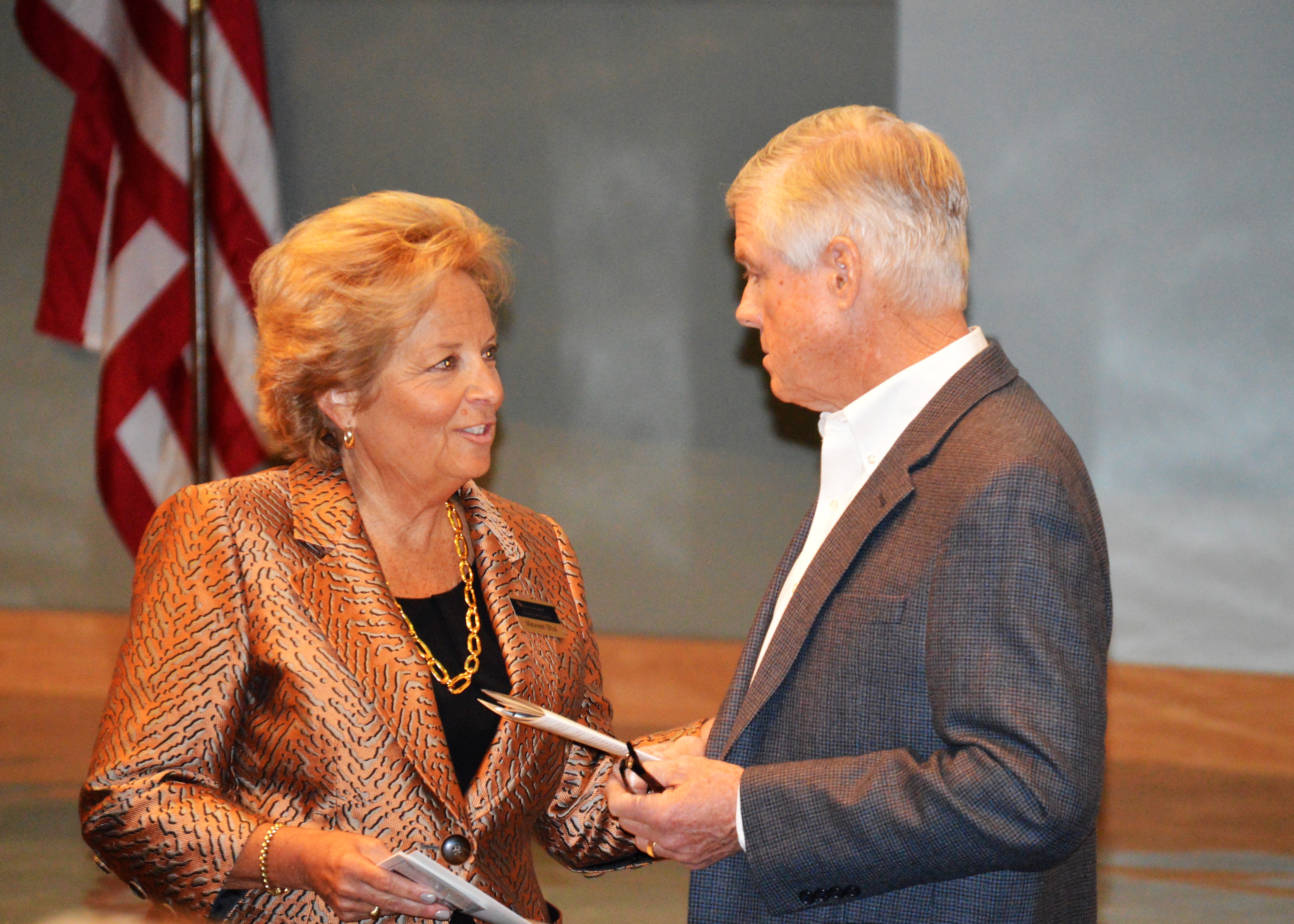 Maureen Shul and board member Jim Comerford chat before the program.