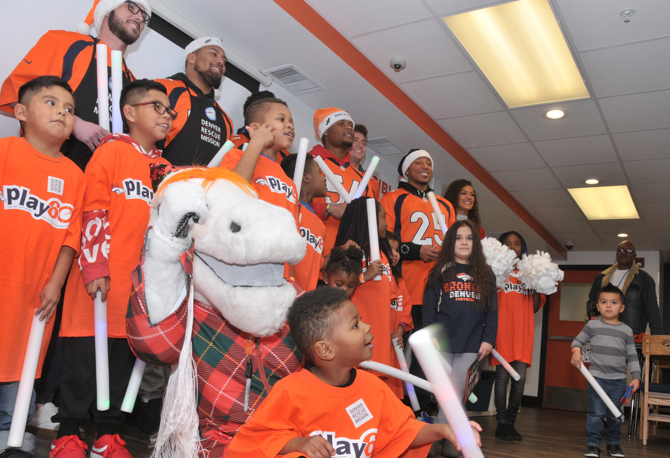 Broncos players pose with kids