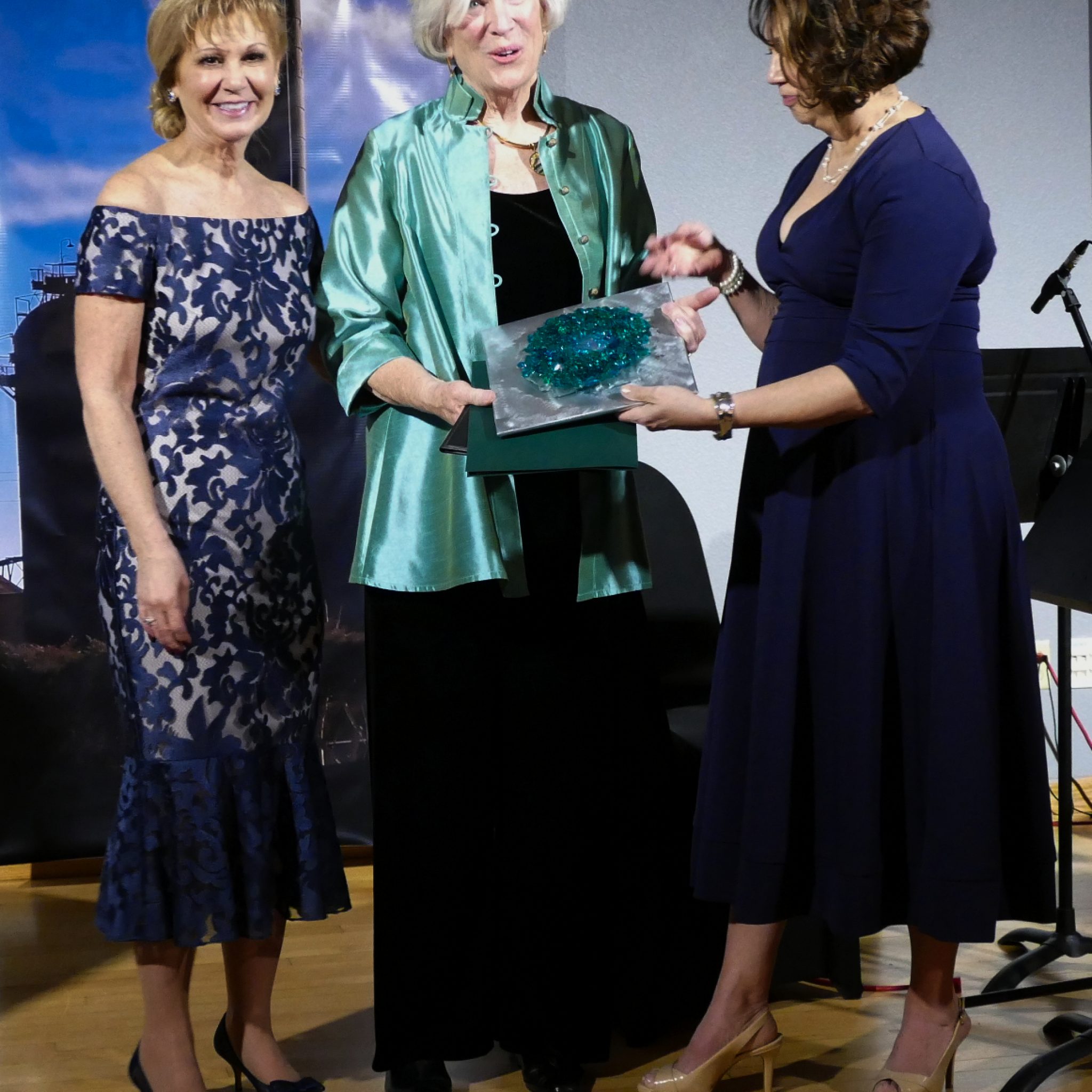 Dr. Patty Erjavec, left, and Theresa Dudley present the HOF award to ...