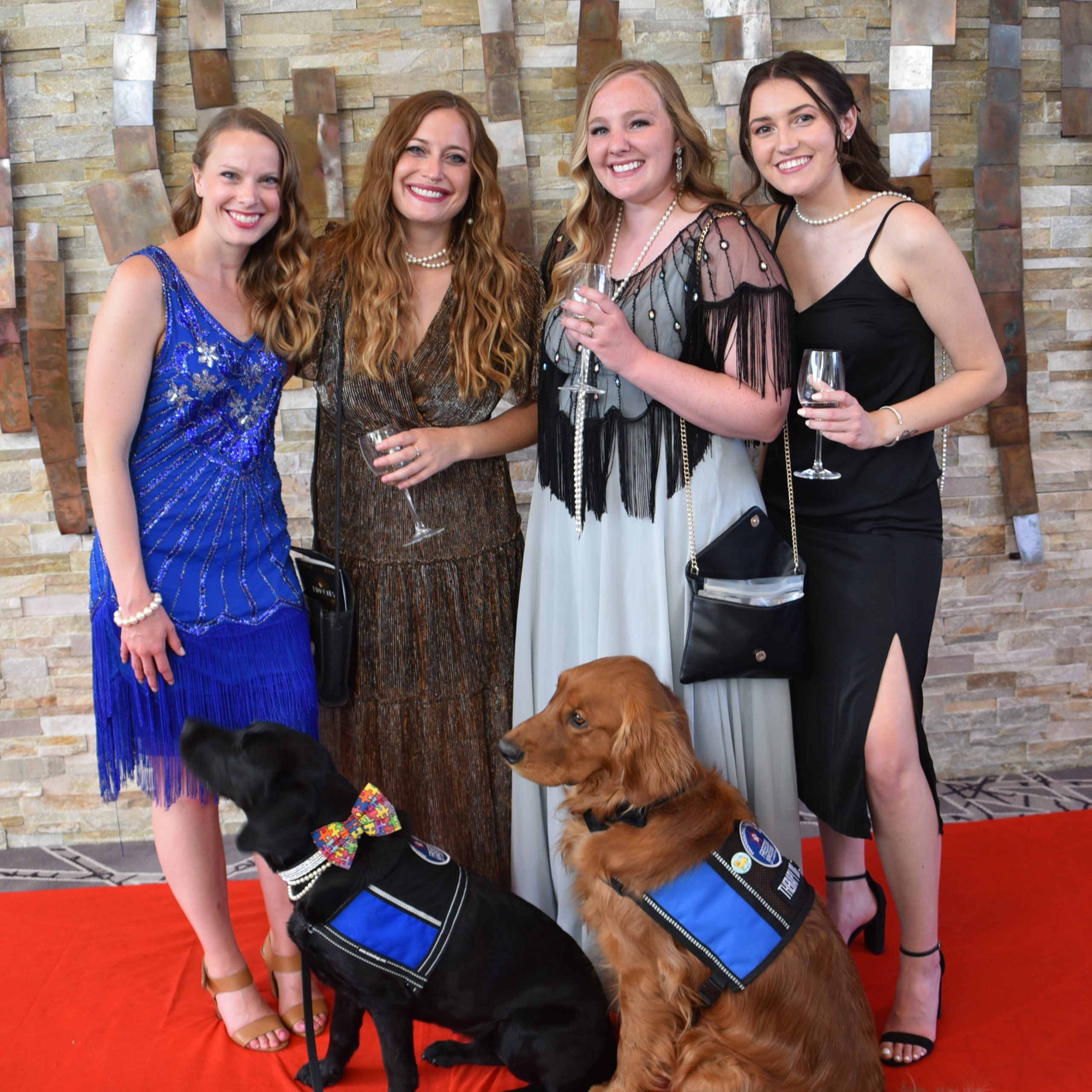 FSD staff Shelby, Sarah, Becca and Leigha with service dogs Lynx and Lucius