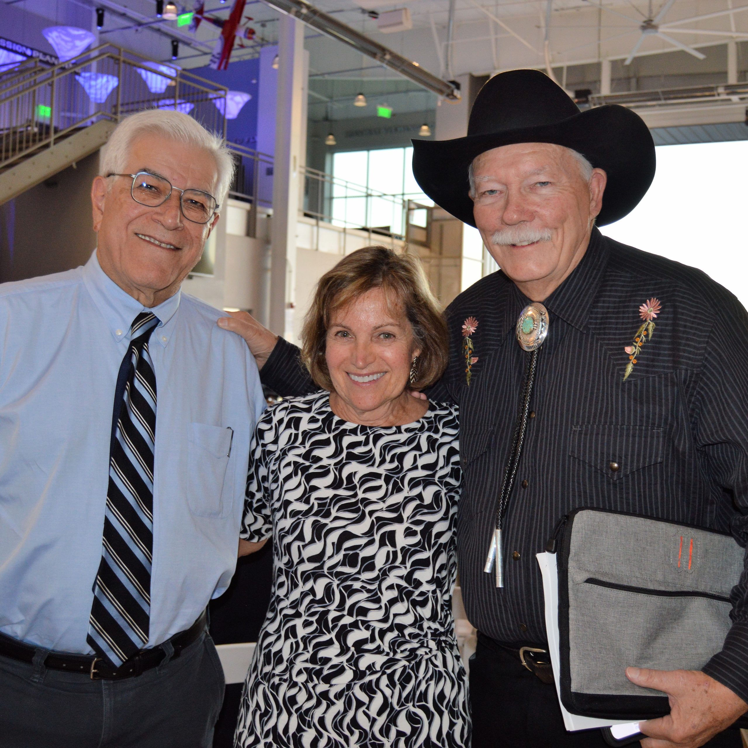 Auctioneer Gary Corbett (right), with Ethan and Nancy Feldman