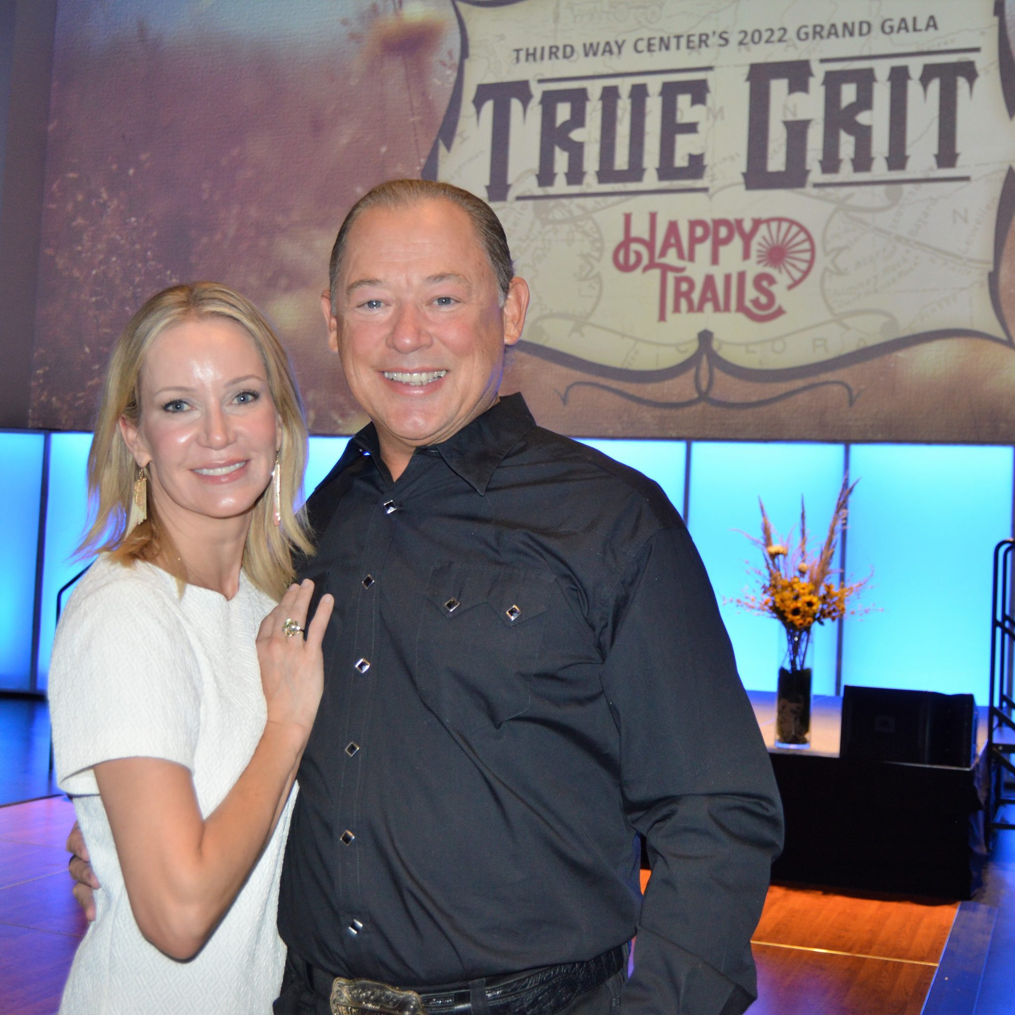 Basking in festive blue lights (l to r): Larry Cohen, auctioneer Jim ...