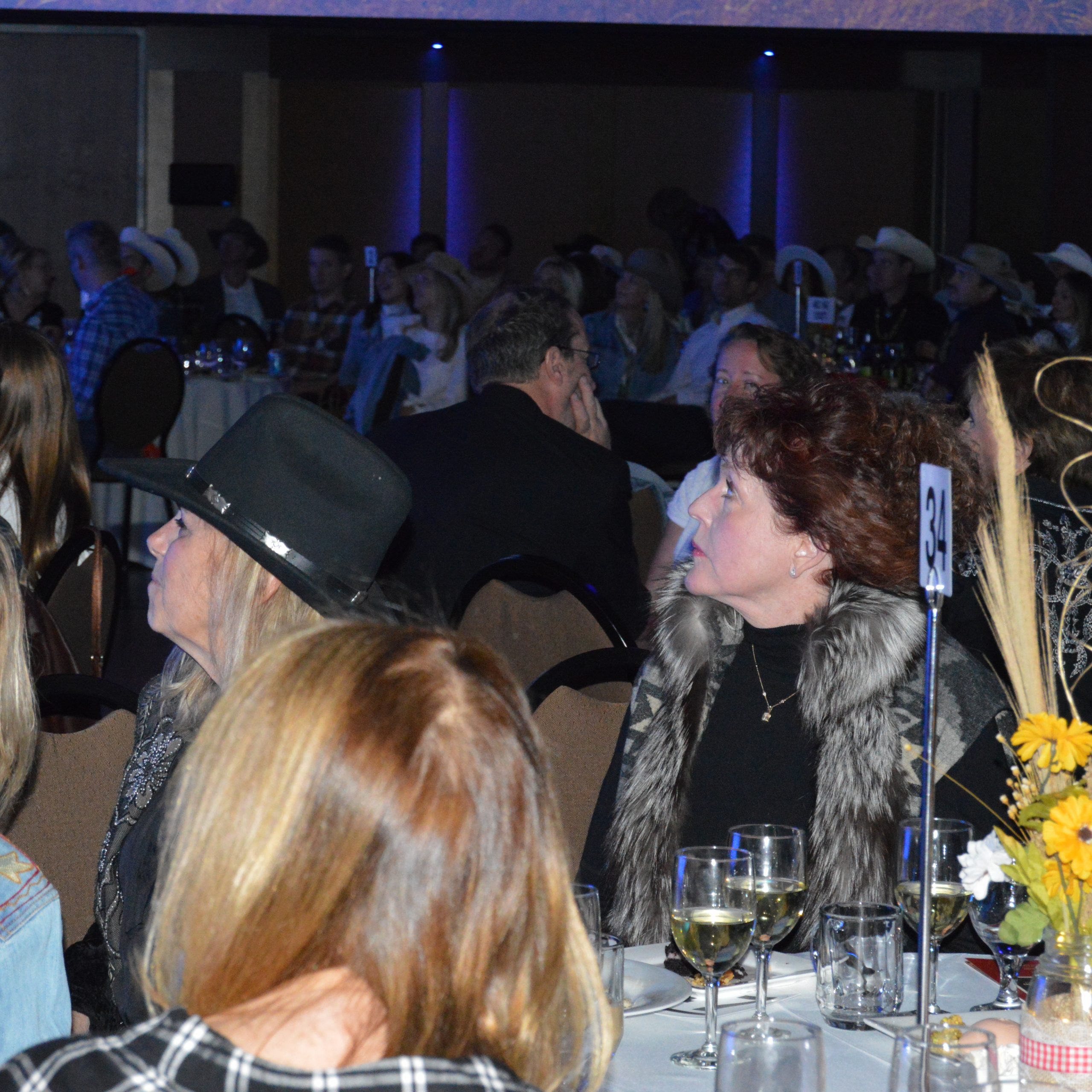 Audience members watch David Eisner's tribute video.