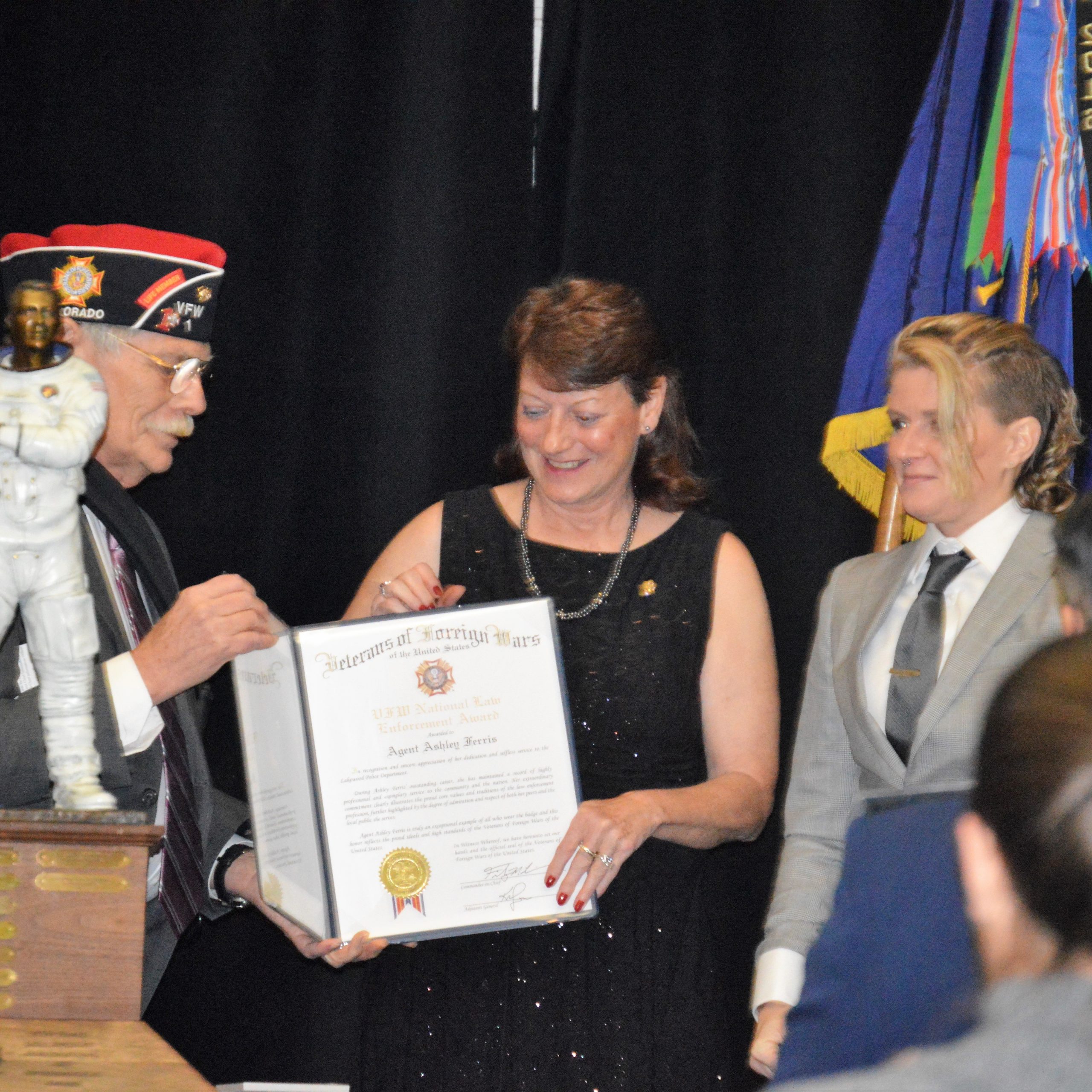 Ashley Ferris (right) is presented with the Law Enforcement Officer of ...