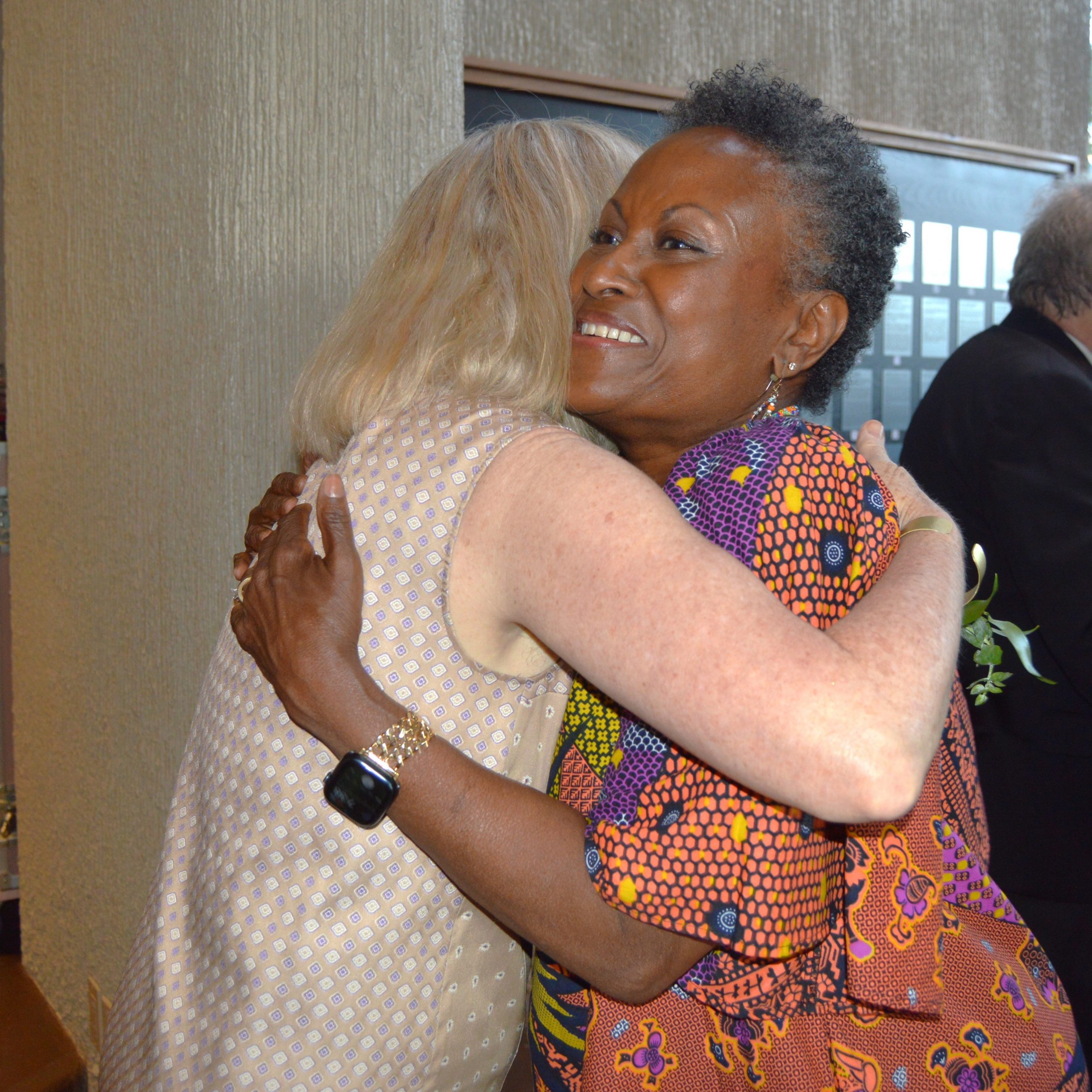 First Lady Helen Thorpe hugs friend Regina Jackson (right)